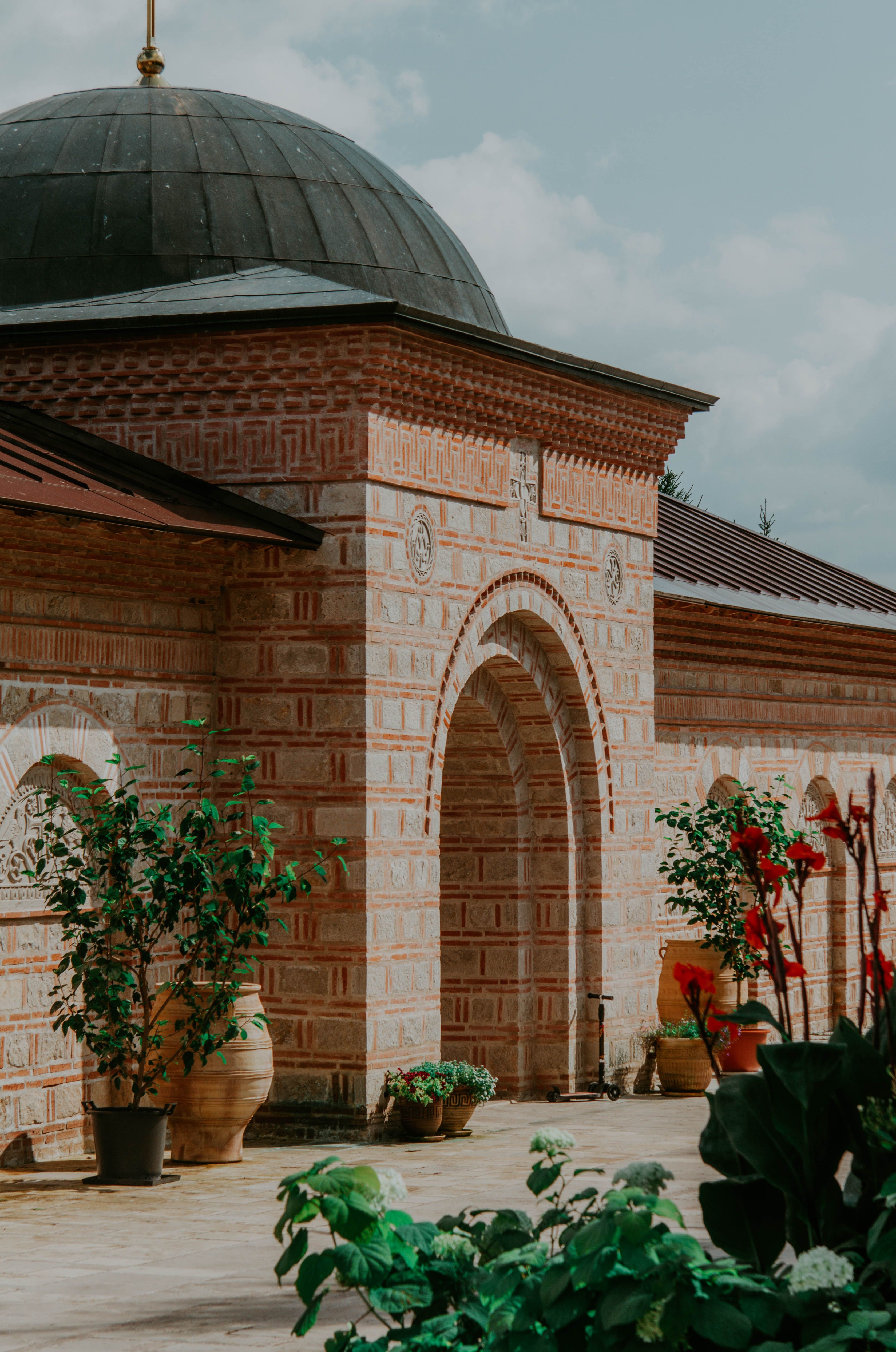 Historic Architectural Building with Potted Plants · Free Stock Photo