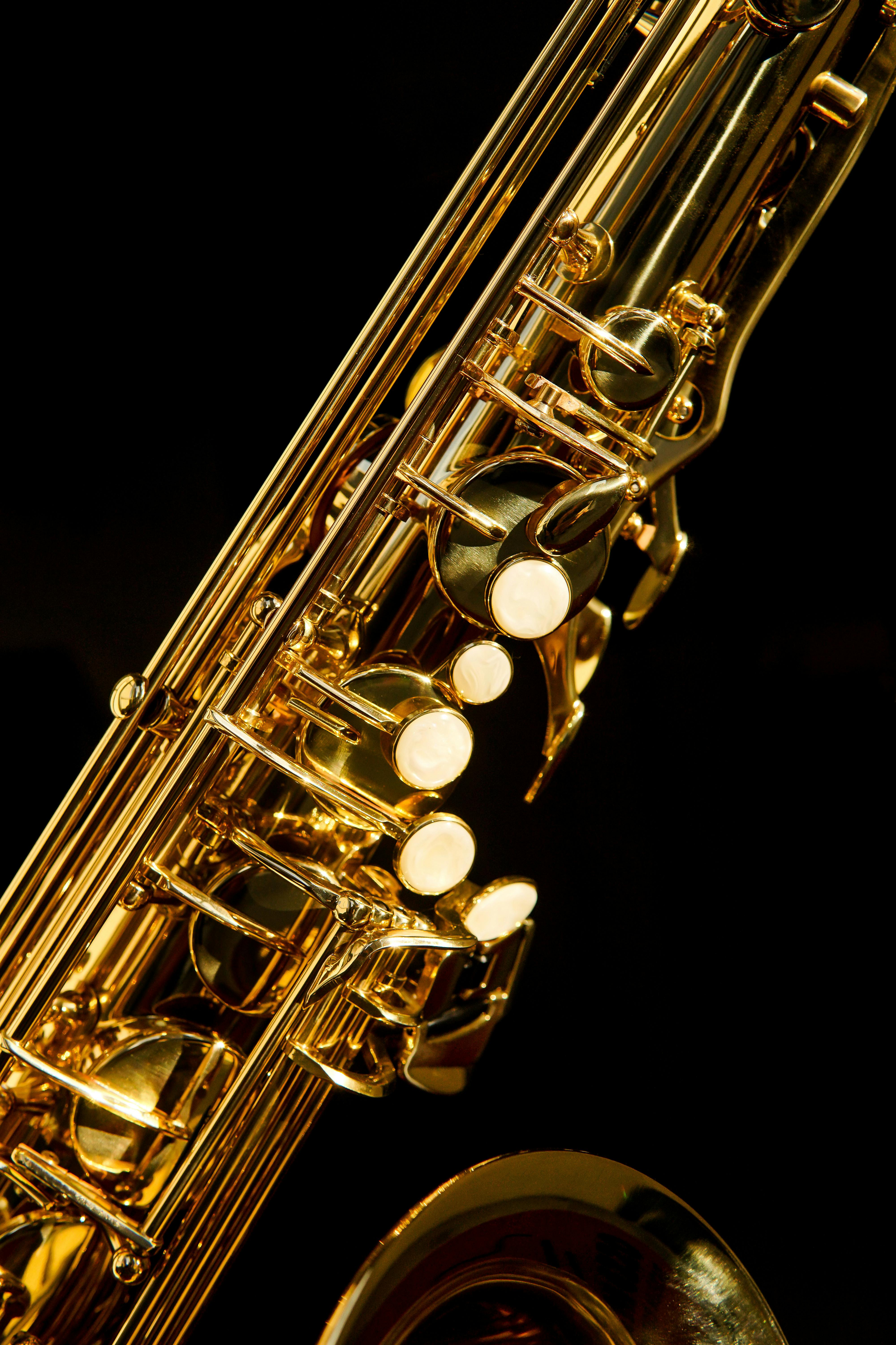 Brass Saxophone on Gray Table Near Black Bag · Free Stock Photo