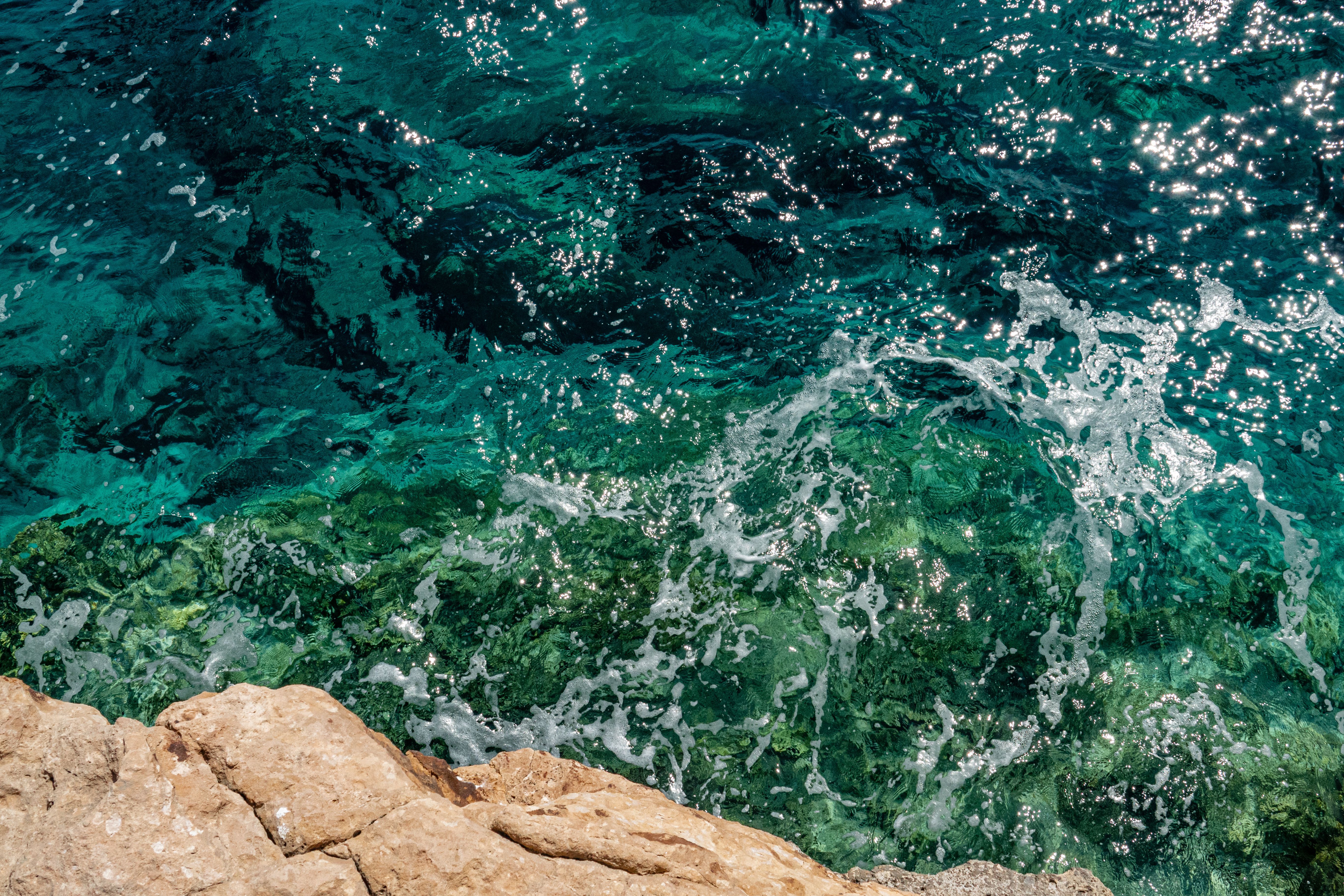 Turquoise Waves Crashing on Rocky Shoreline · Free Stock Photo