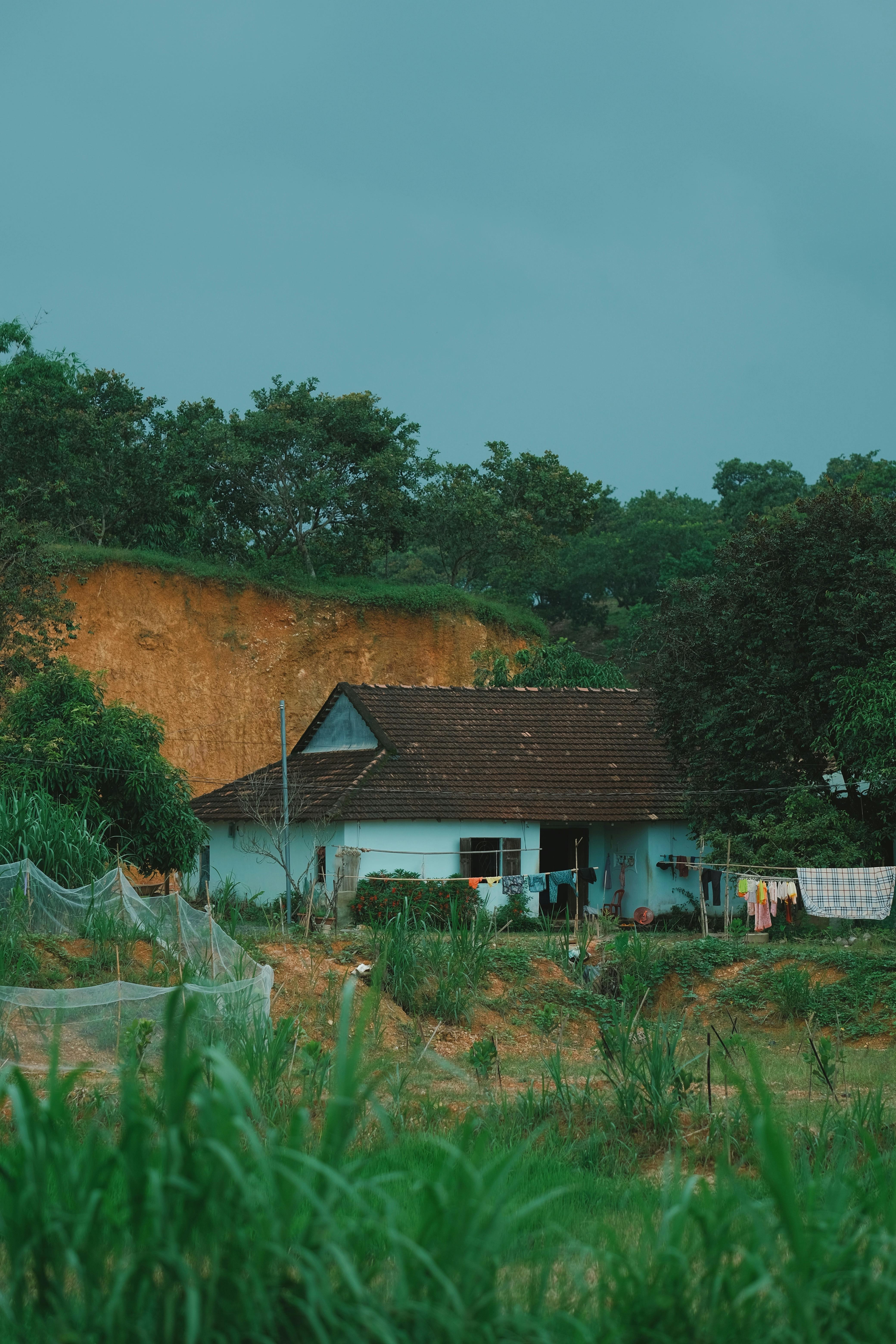 House Surrounded by Green Grass Below Clouds and Sky · Free Stock Photo