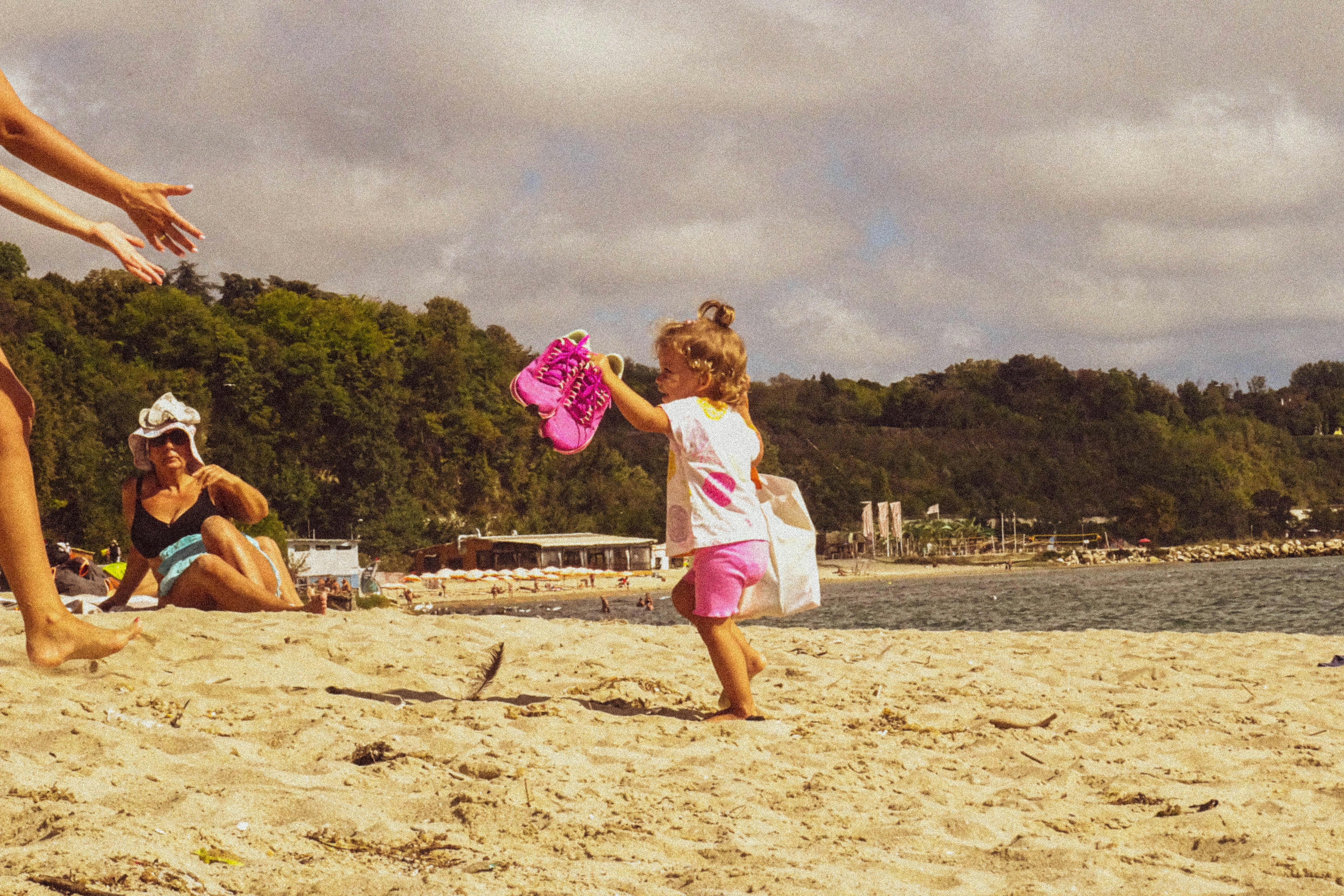 Joyful beach day with family interactions · Free Stock Photo