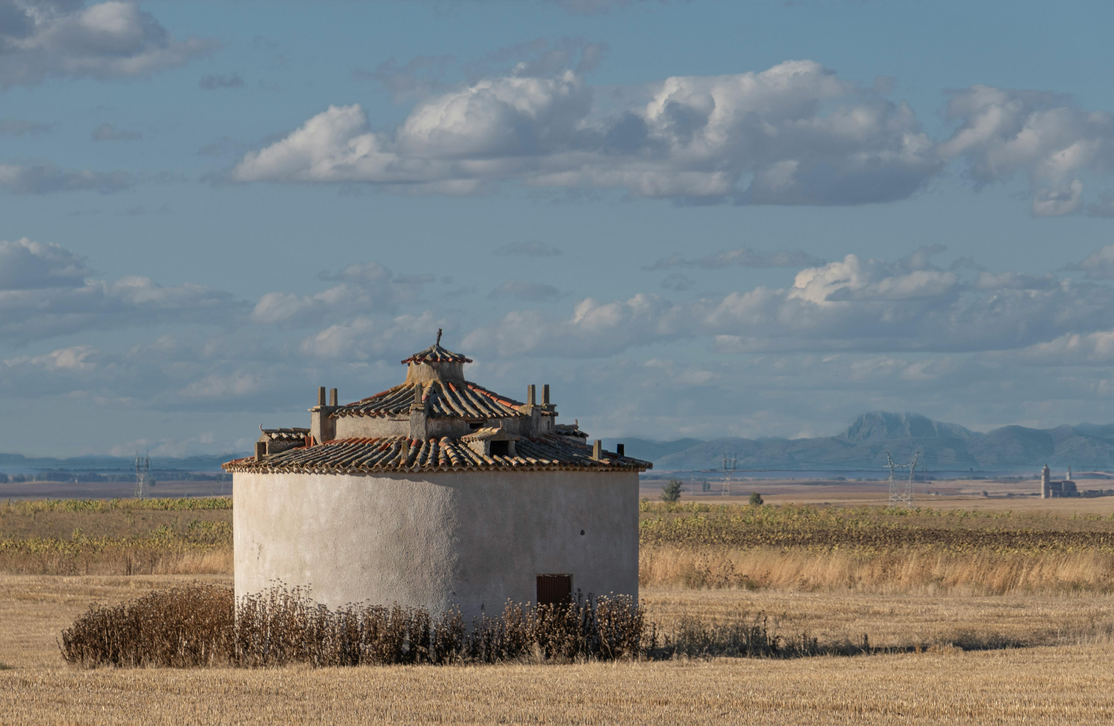 Round Stone Building in Rural Landscape · Free Stock Photo