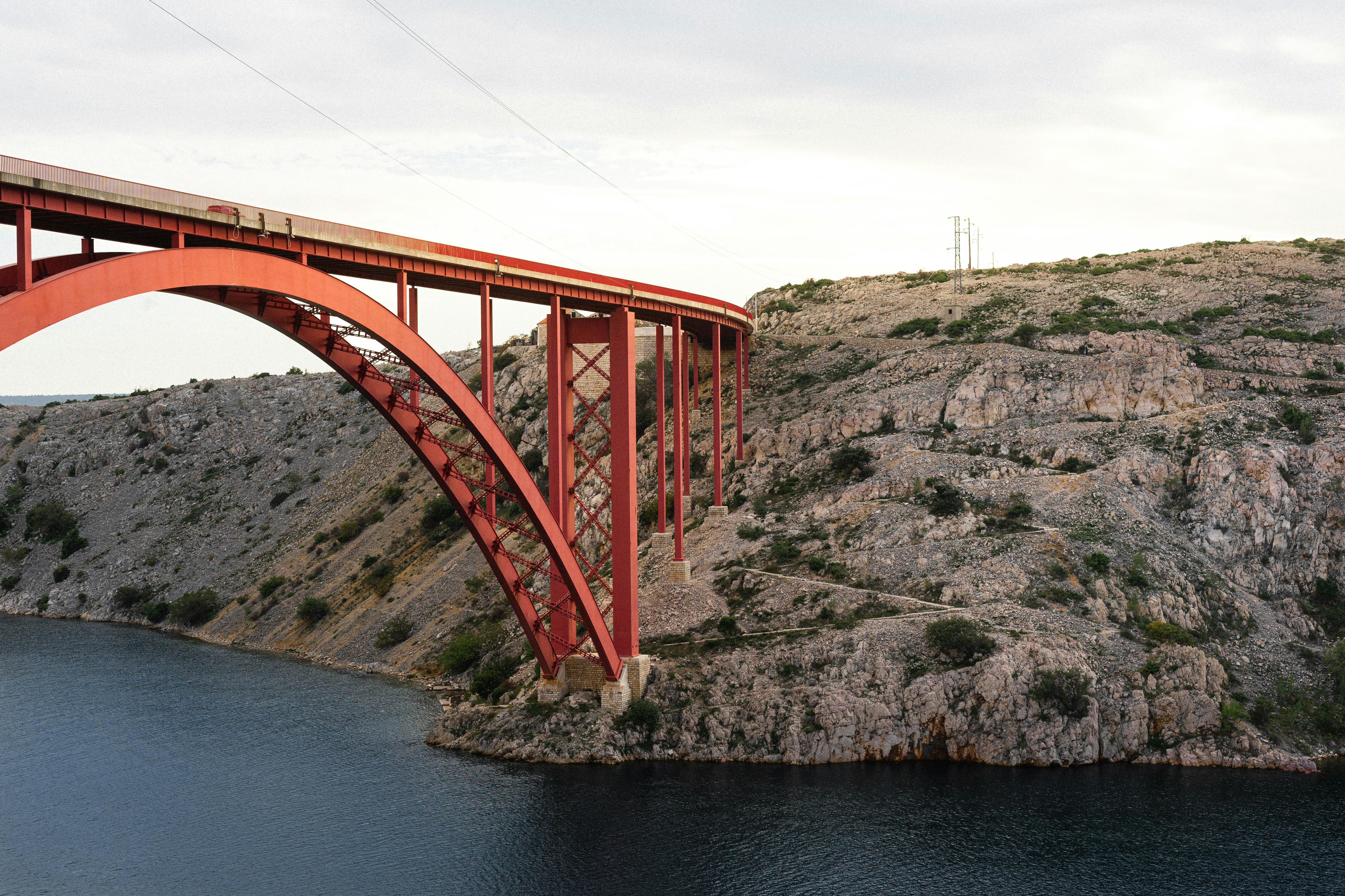 Grey Concrete Bridge Above Water Under Blue Sky · Free Stock Photo