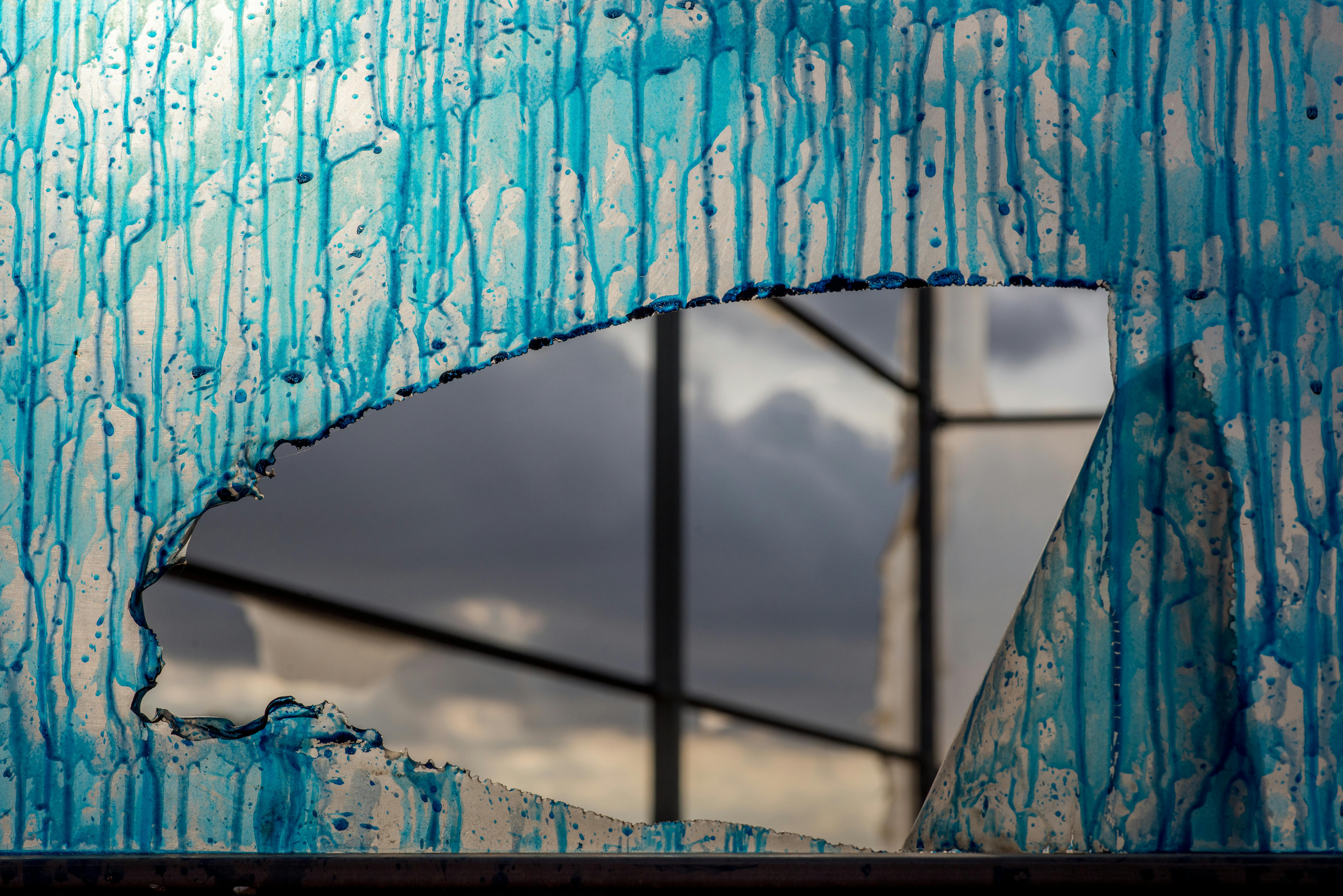 Artistic View Through Blue Paint-Splattered Glass · Free Stock Photo