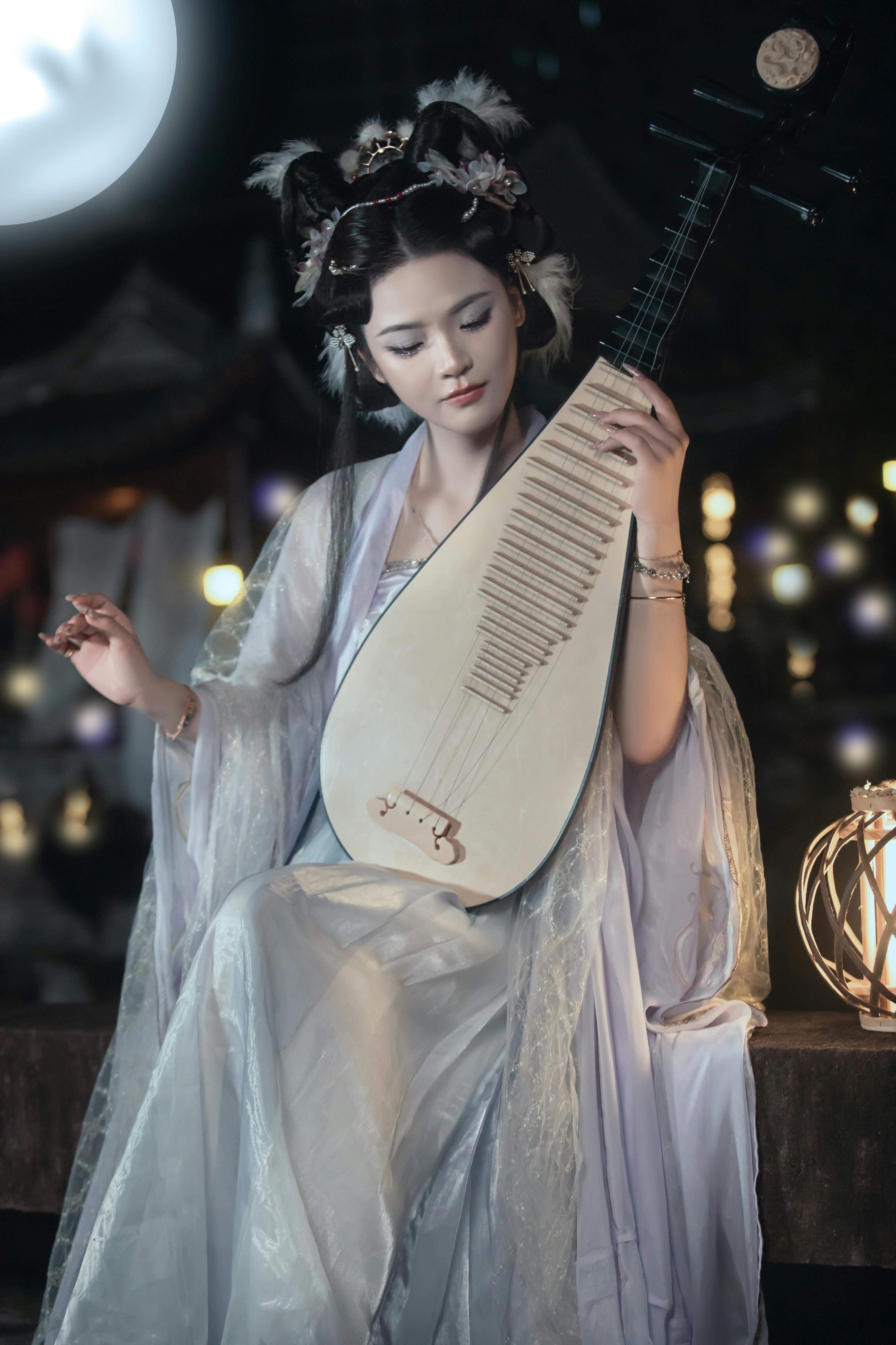 Elegantly Dressed Woman Playing a Pipa · Free Stock Photo