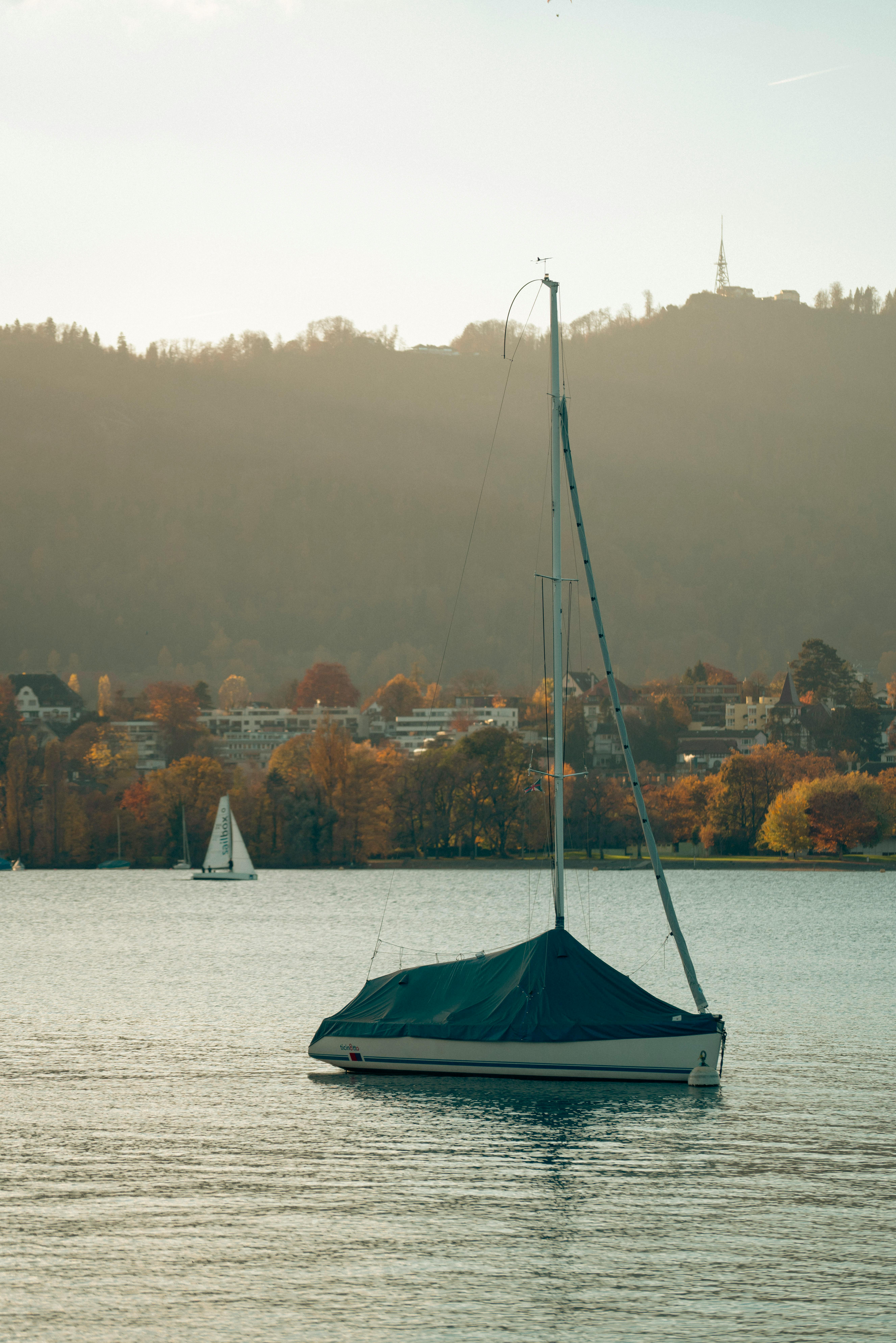 Serene Autumn Lake View with Sailboat · Free Stock Photo