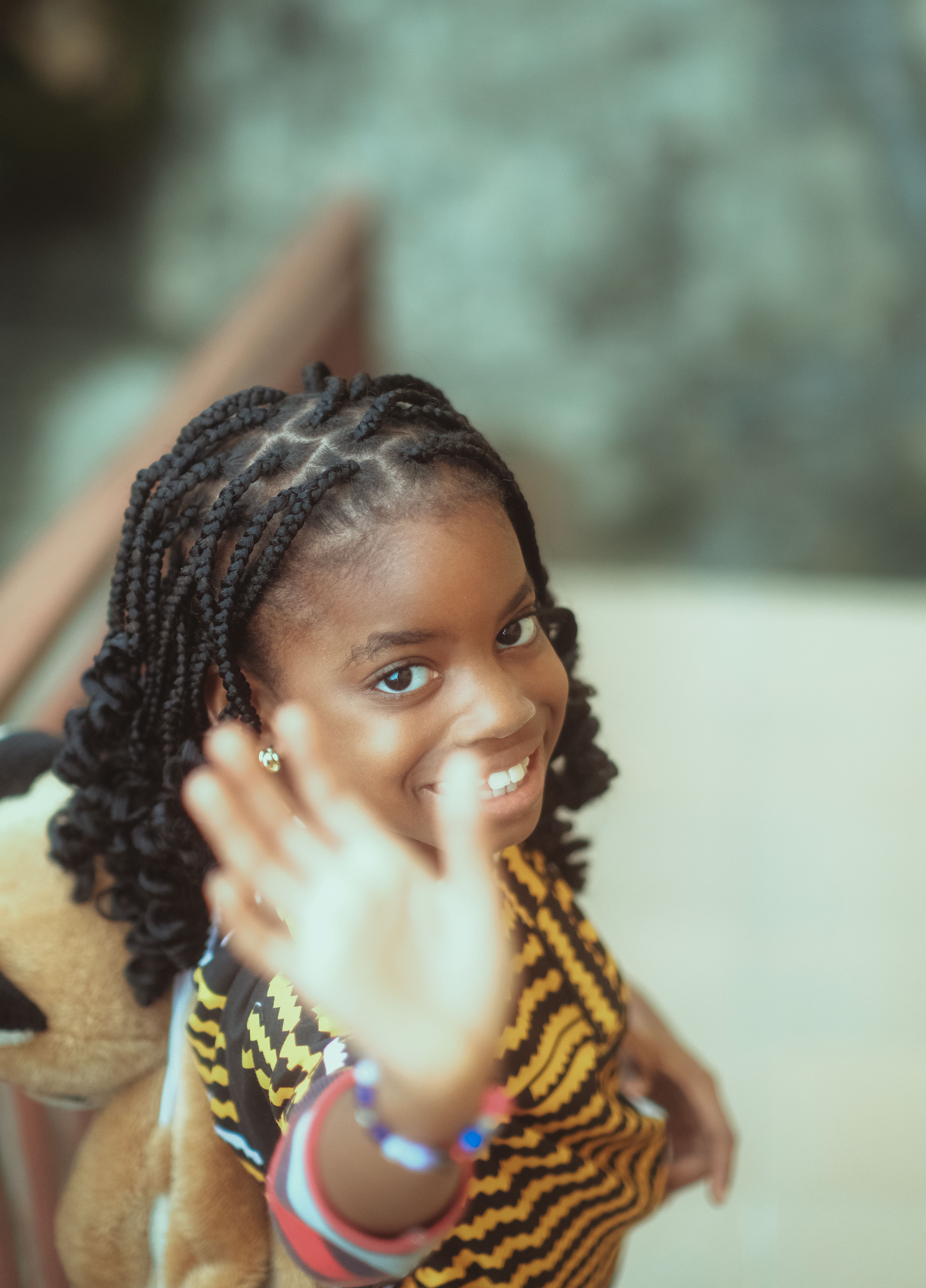 Smiling Child Waving with Joyful Expression · Free Stock Photo