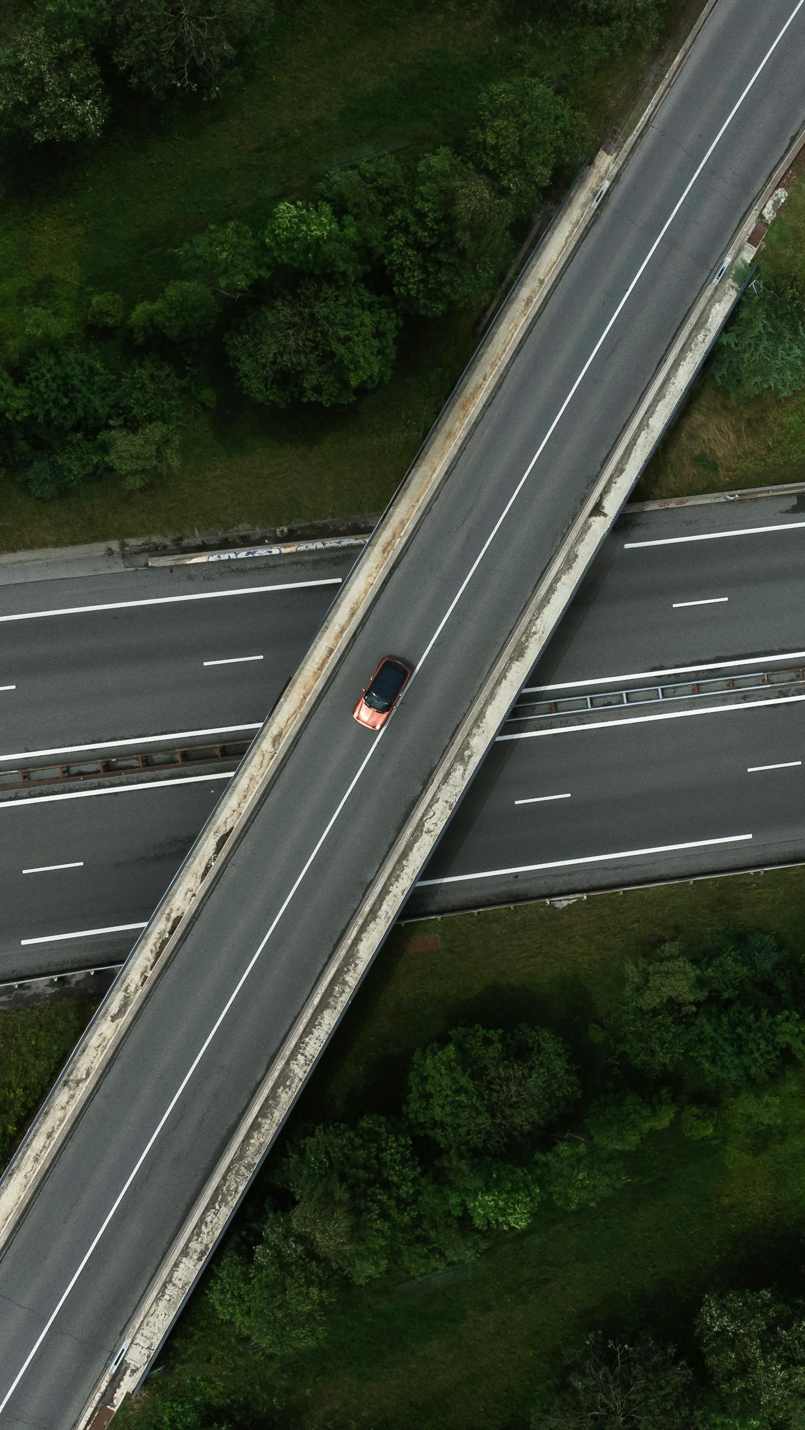 Aerial View of Car on Dual Highway Intersection · Free Stock Photo