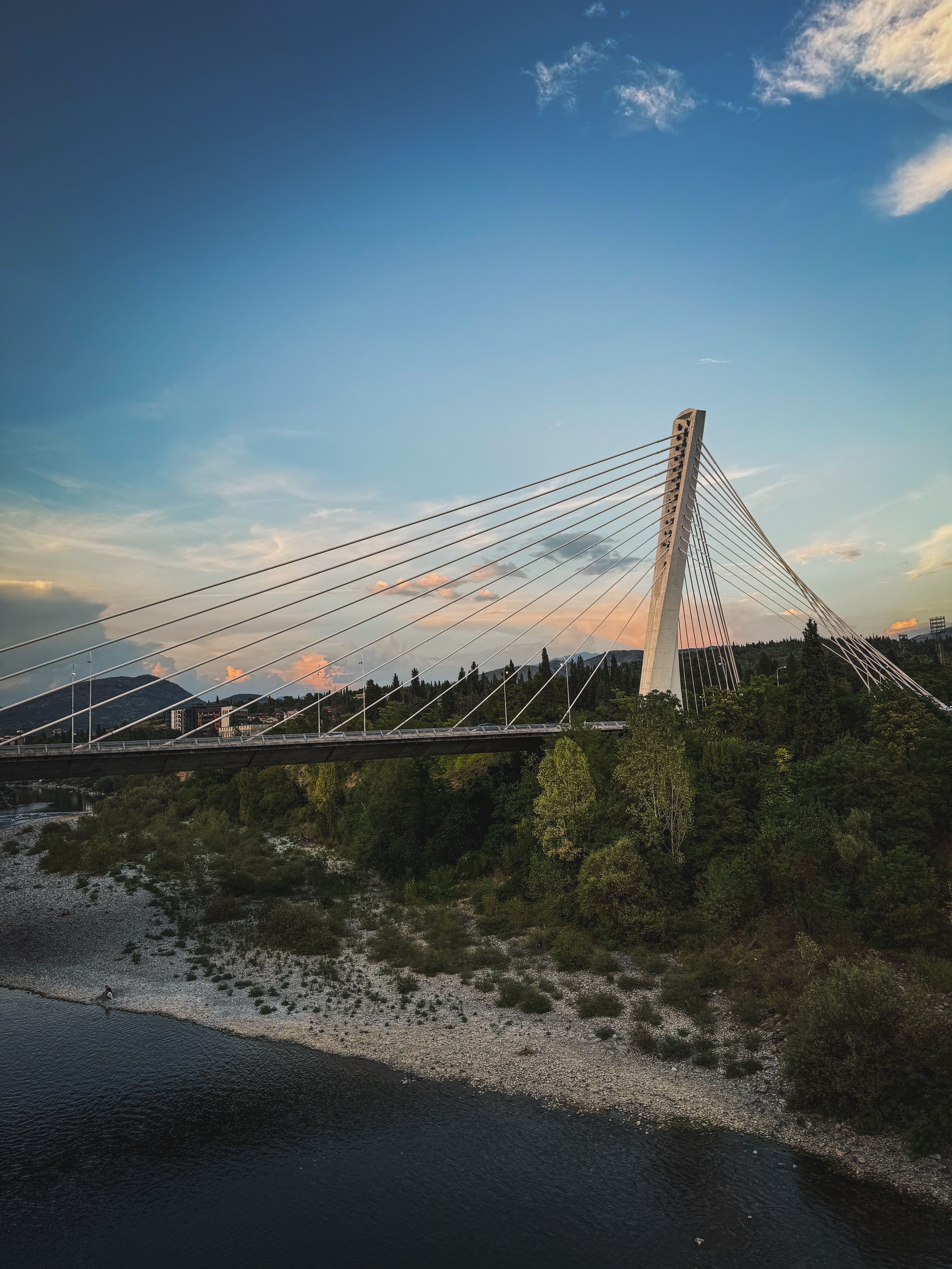 Suspension Bridge Over River at Sunset · Free Stock Photo