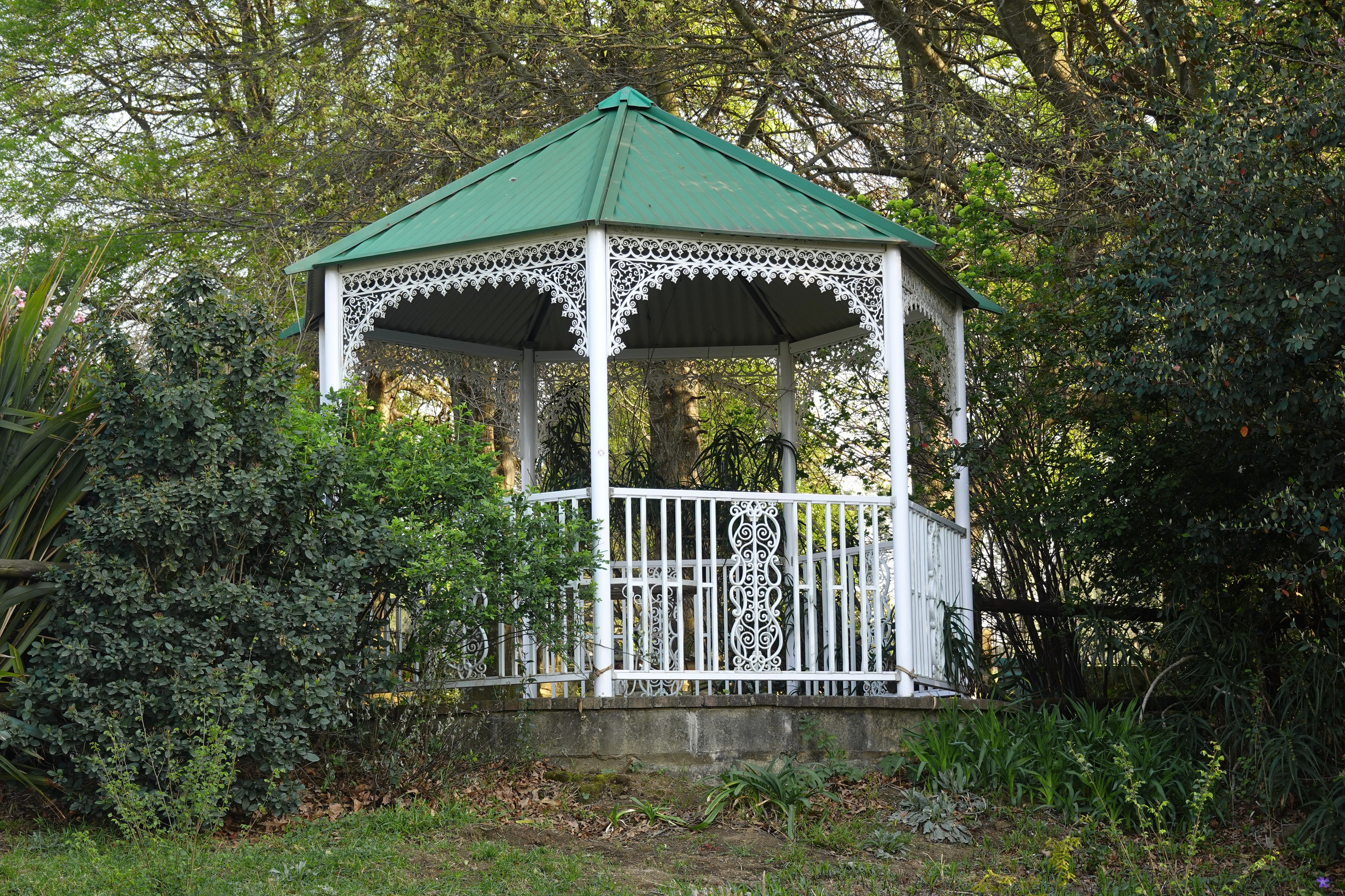 Charming White Gazebo in Lush Garden Setting · Free Stock Photo