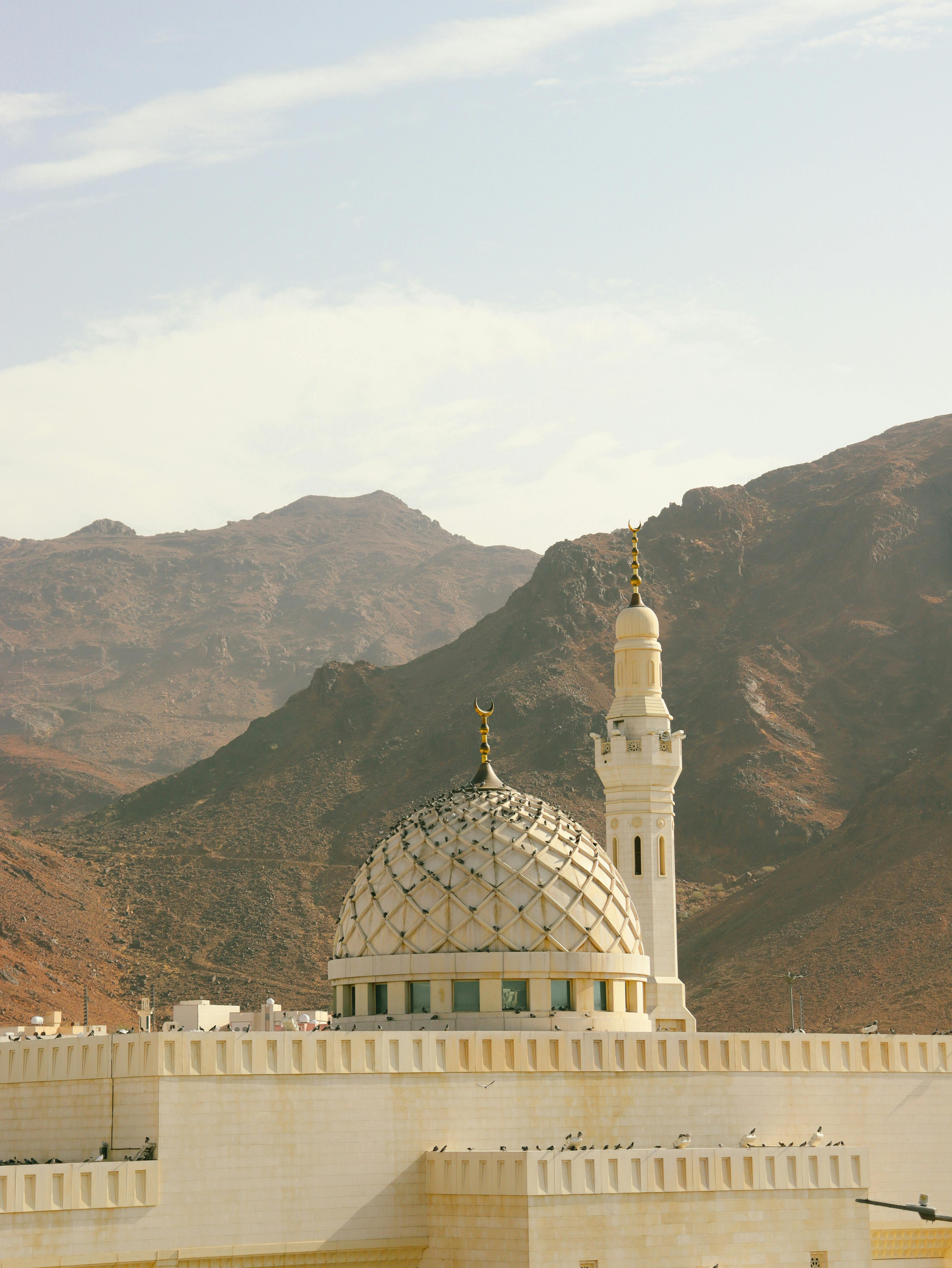 Scenic Mosque View Against Mountain Backdrop · Free Stock Photo