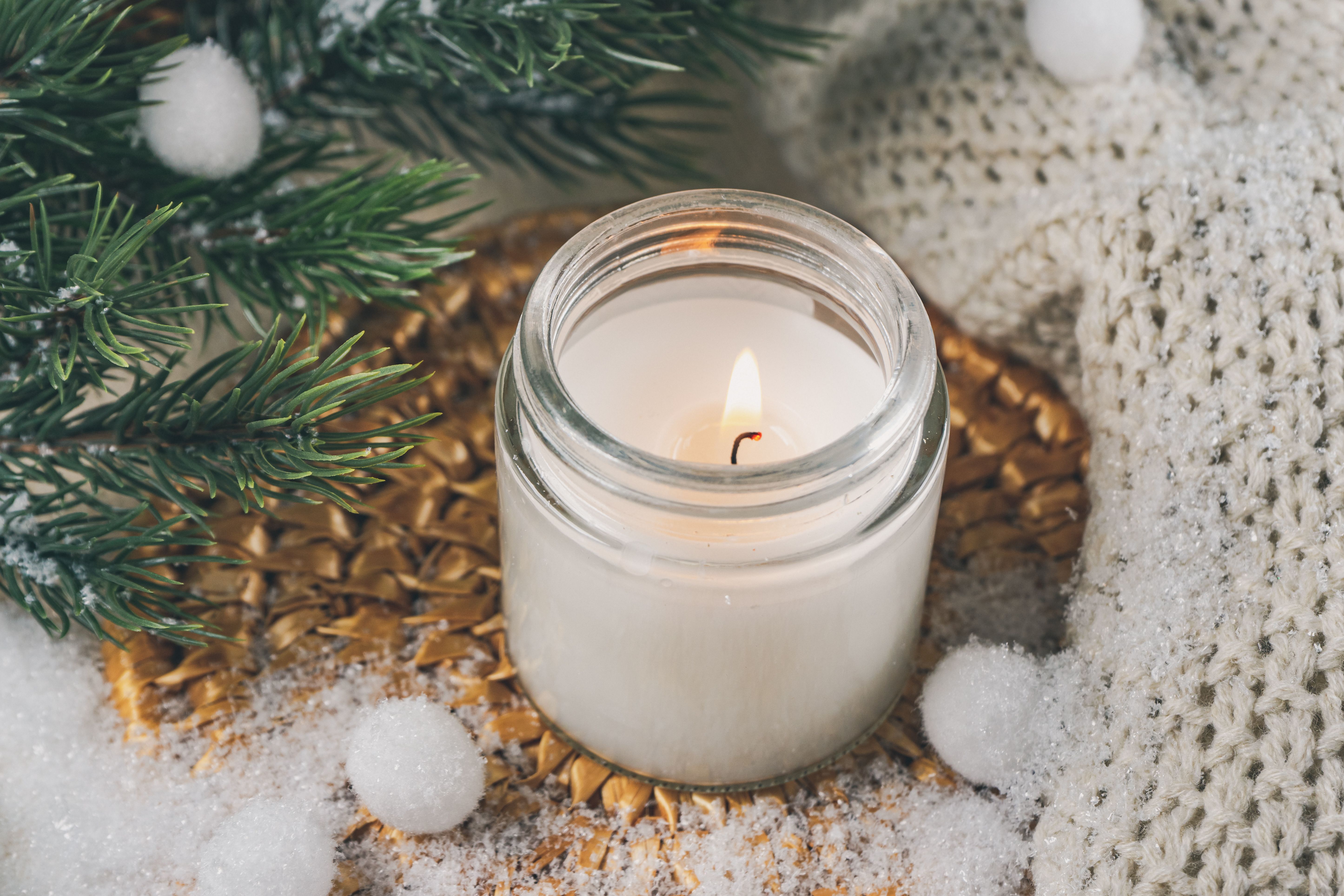 Cozy Winter Scene with Candle and Snow · Free Stock Photo
