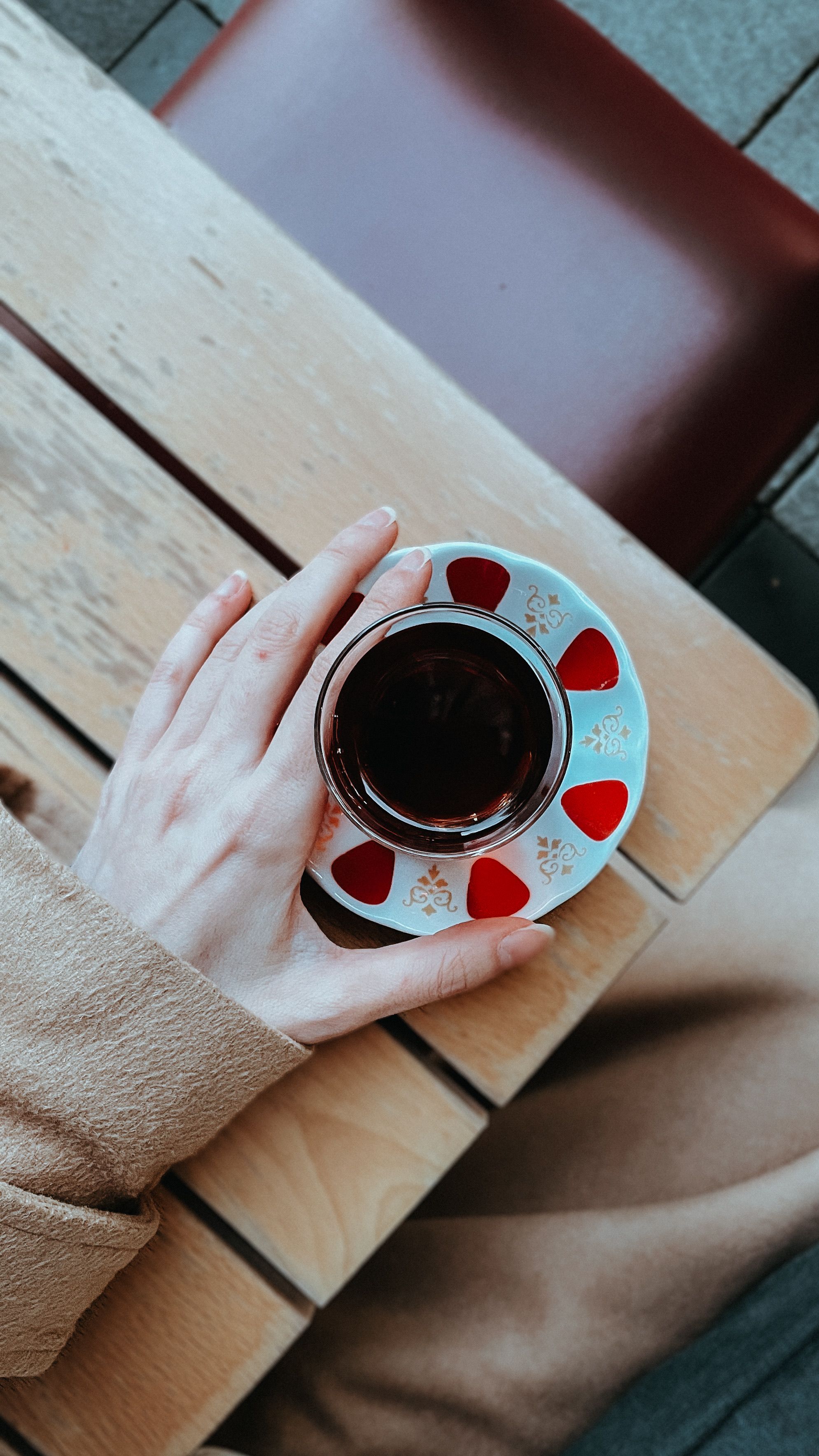 Overhead View of Person Holding Coffee Cup Outdoors · Free Stock Photo