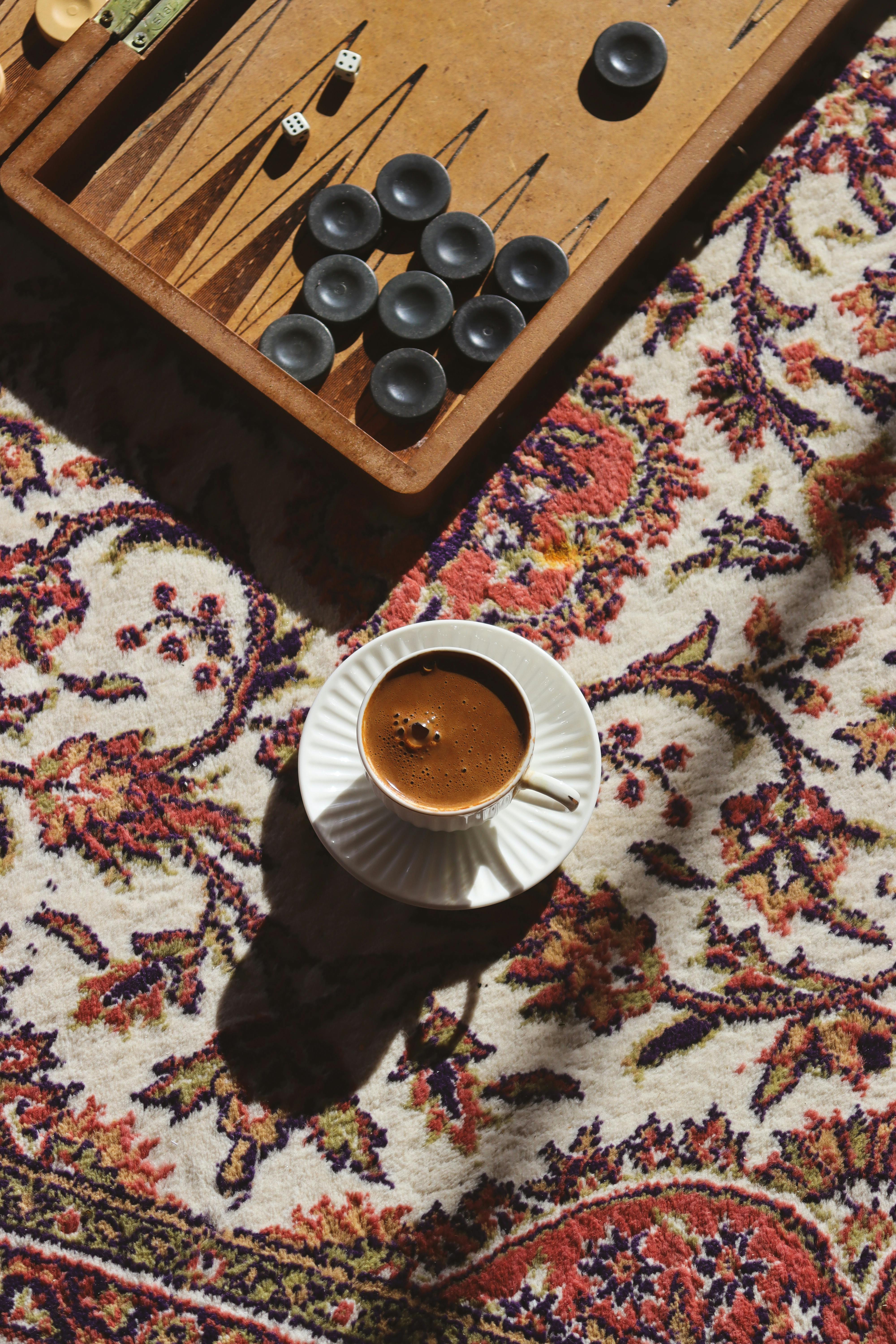 Cozy Coffee Cup and Backgammon on Persian Rug · Free Stock Photo