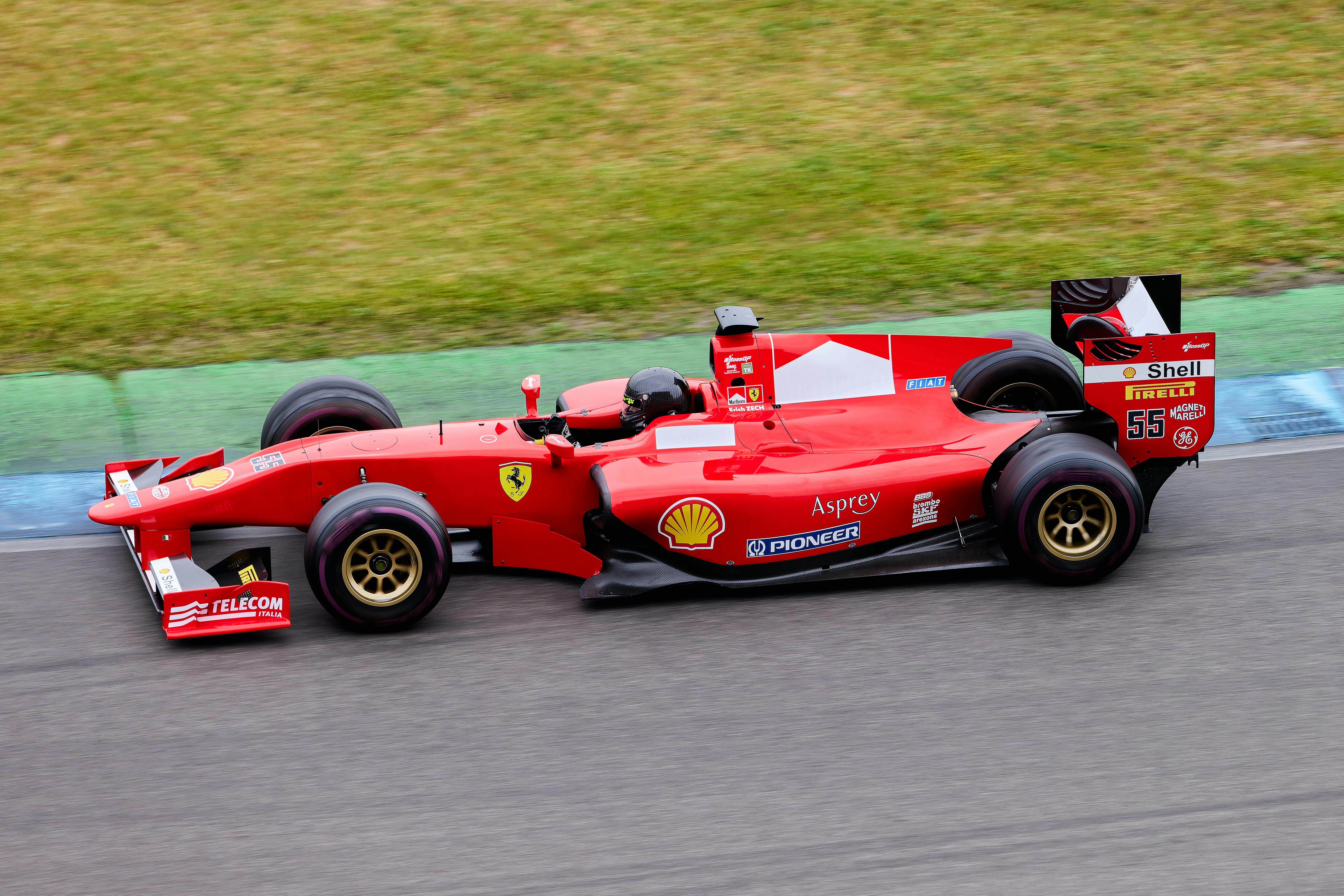 Dynamic Red Formula 1 Racing Car on Track · Free Stock Photo