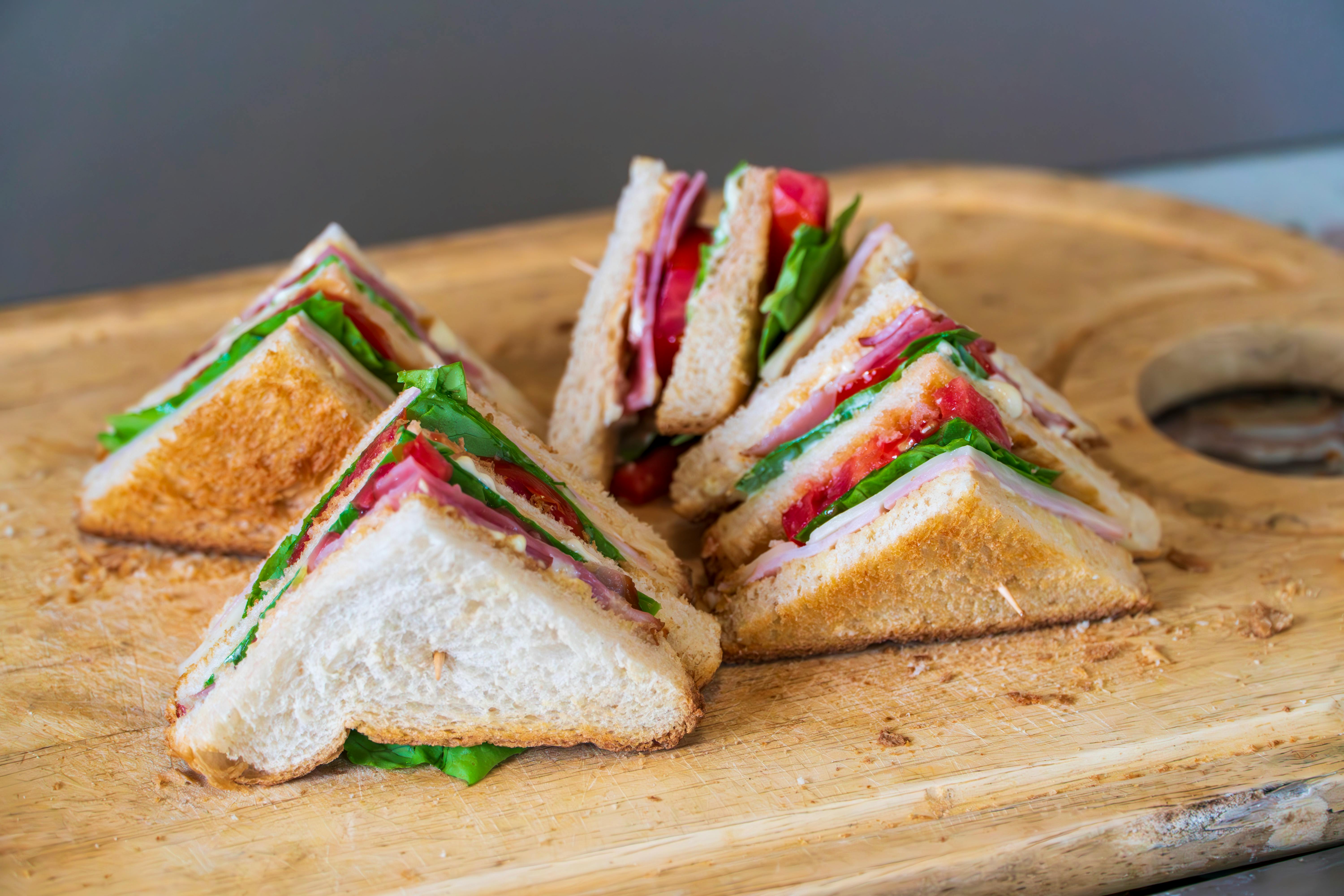 Delicious Club Sandwich on Wooden Board · Free Stock Photo