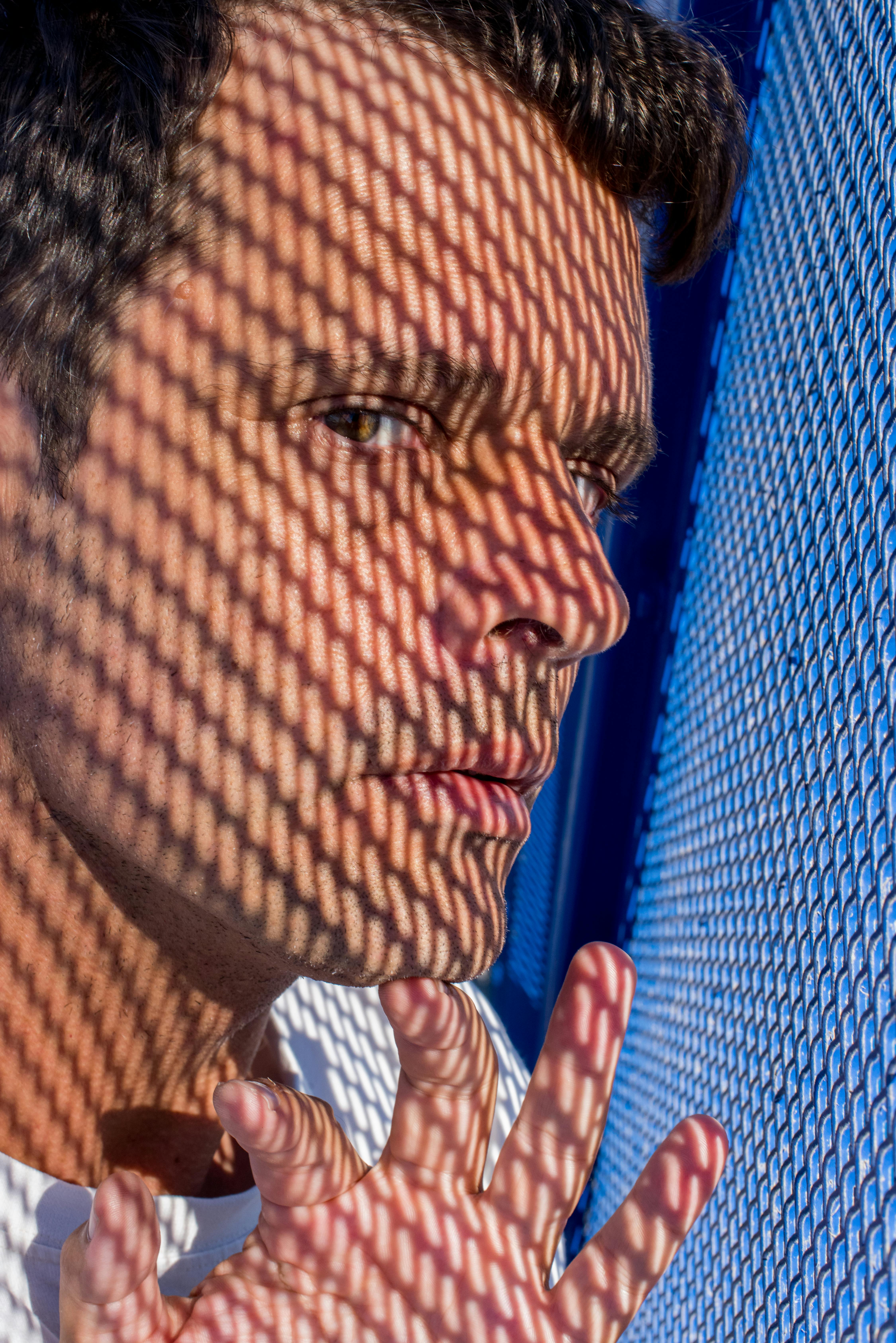 Man in Artistic Shadowed Portrait Outdoors · Free Stock Photo