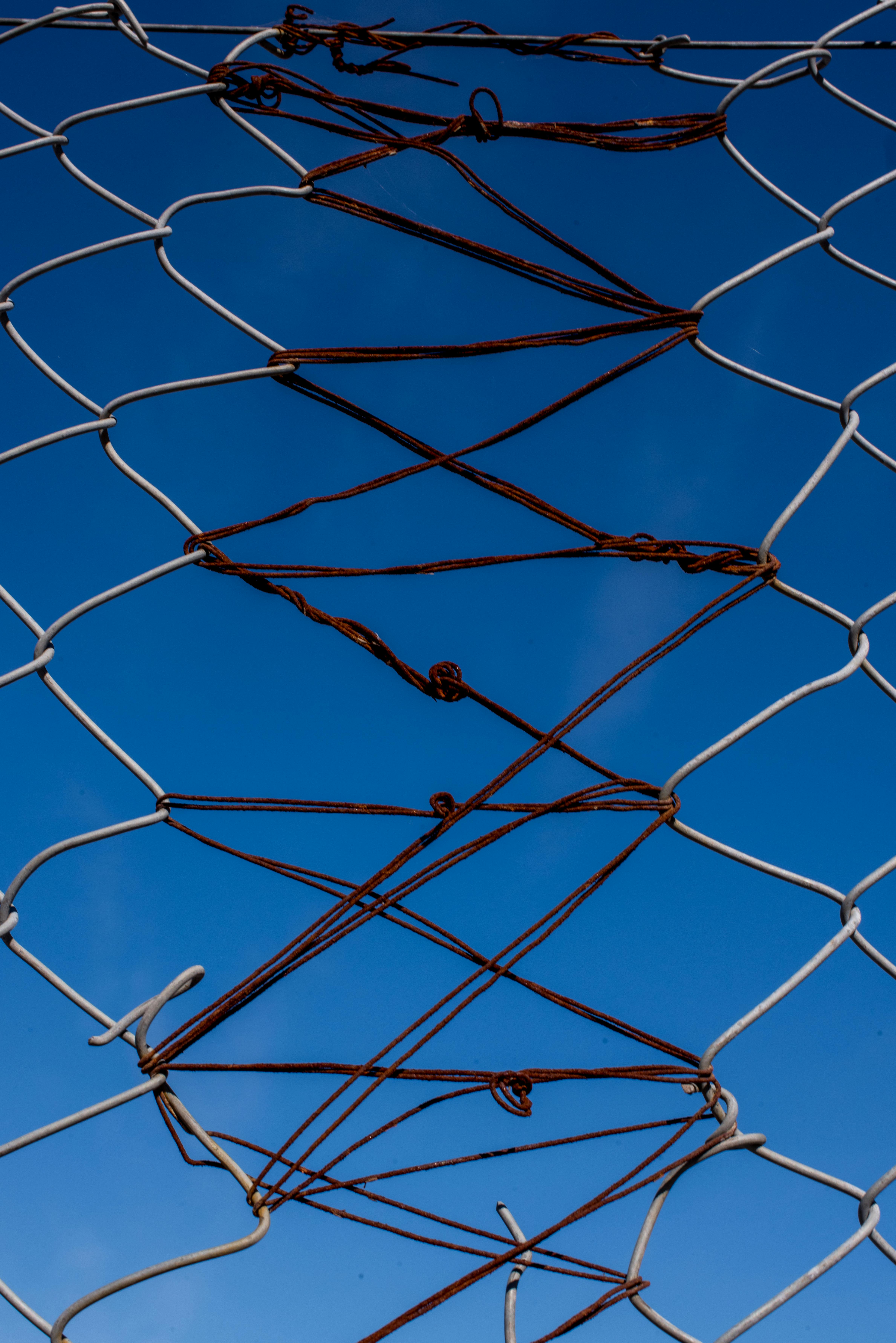 Rusty Wire Fence Against Clear Blue Sky · Free Stock Photo
