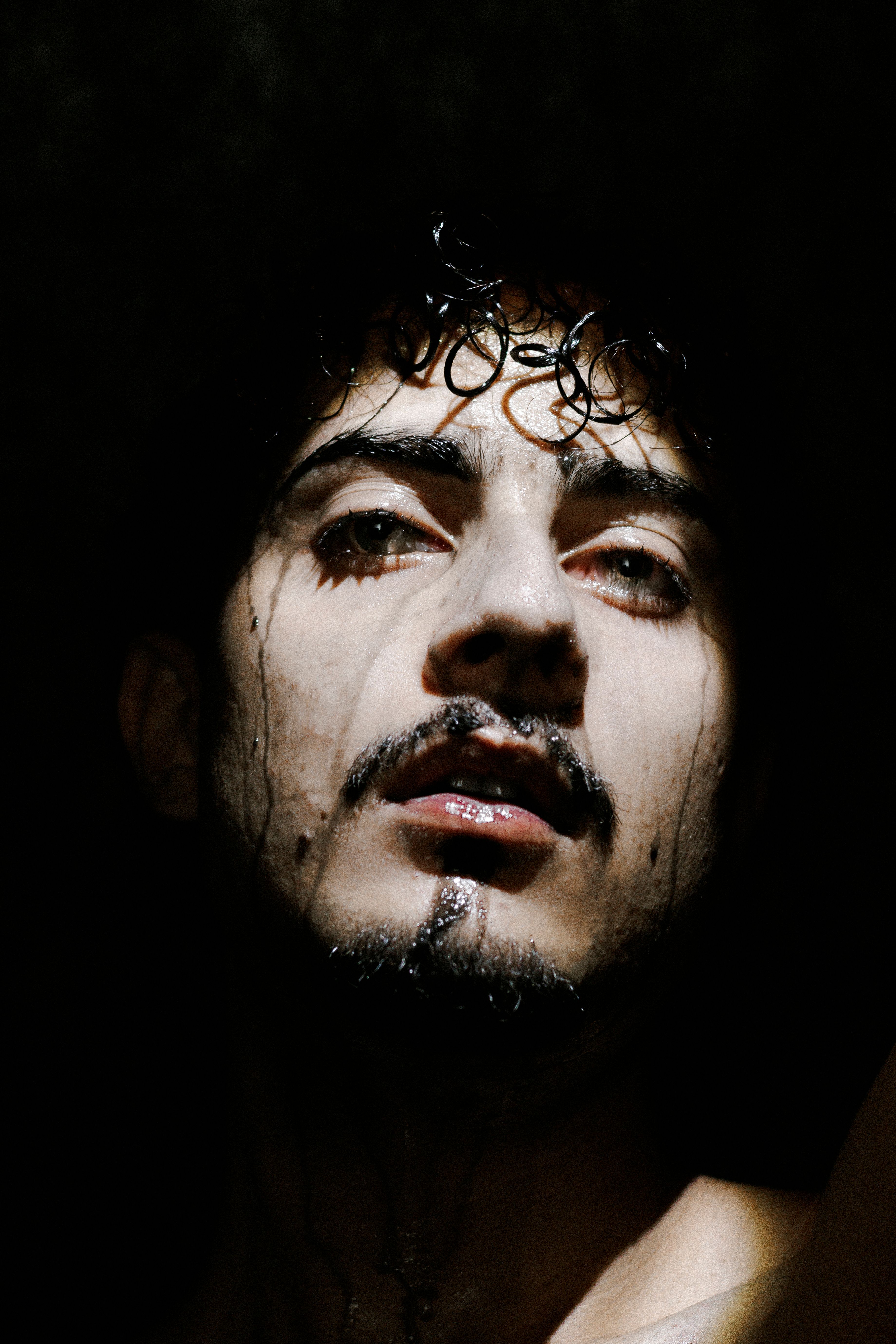 Dramatic Portrait of a Man in Shadowed Lighting · Free Stock Photo