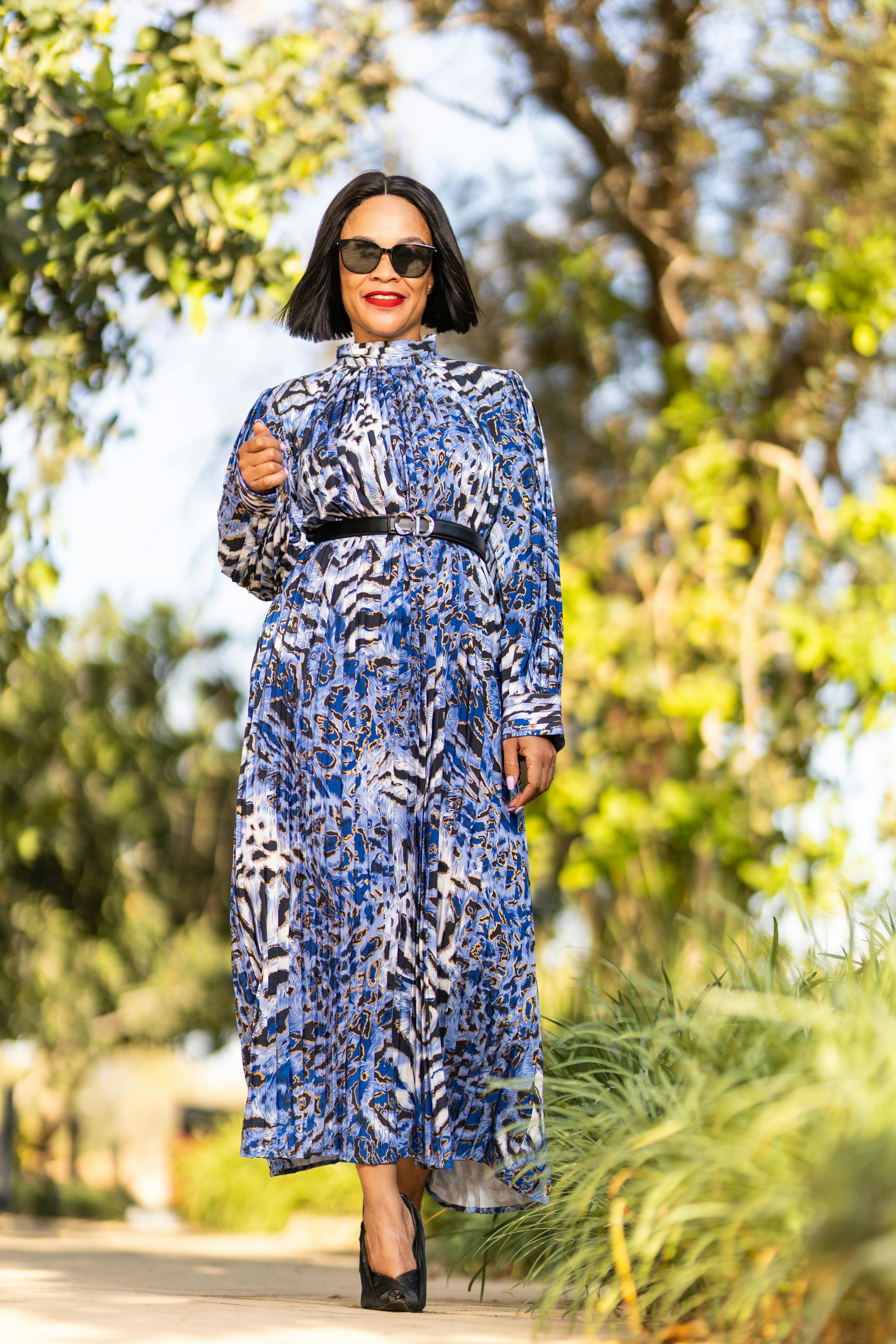 Elegant Woman in Blue Pattern Dress Outdoors · Free Stock Photo