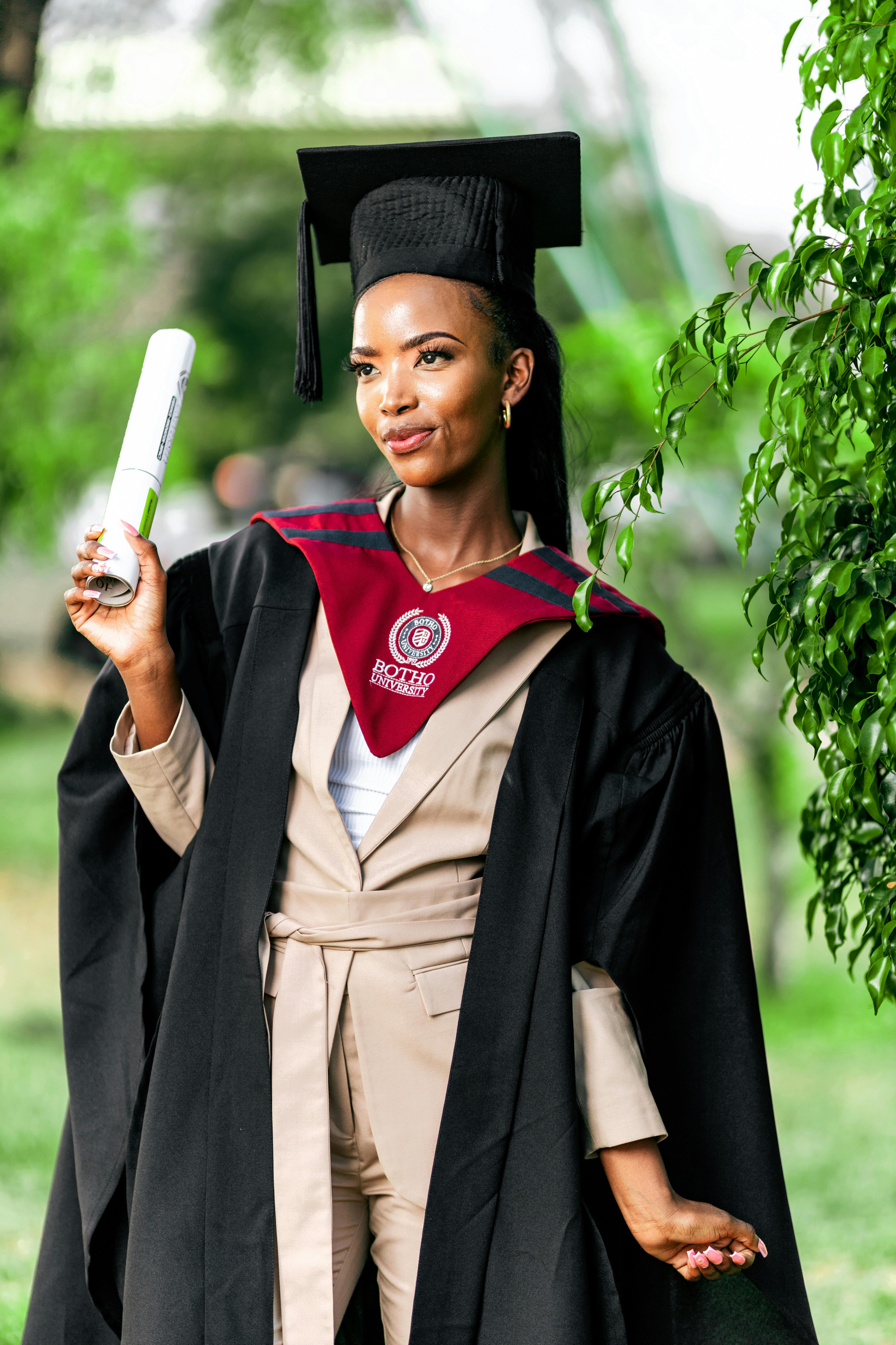 Graduation Day: Proud Graduate Holding Diploma Outdoors · Free Stock Photo