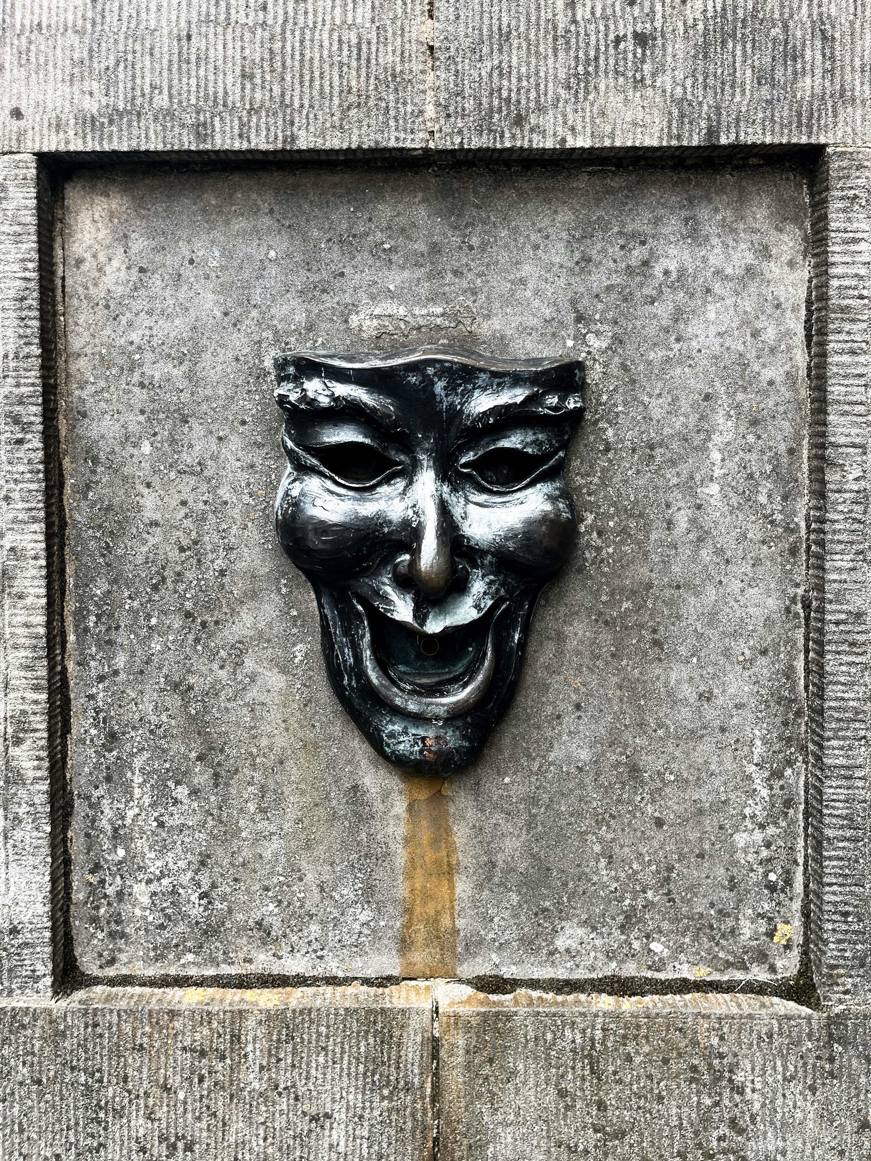 Ancient Comedy Mask on Historical Wall · Free Stock Photo