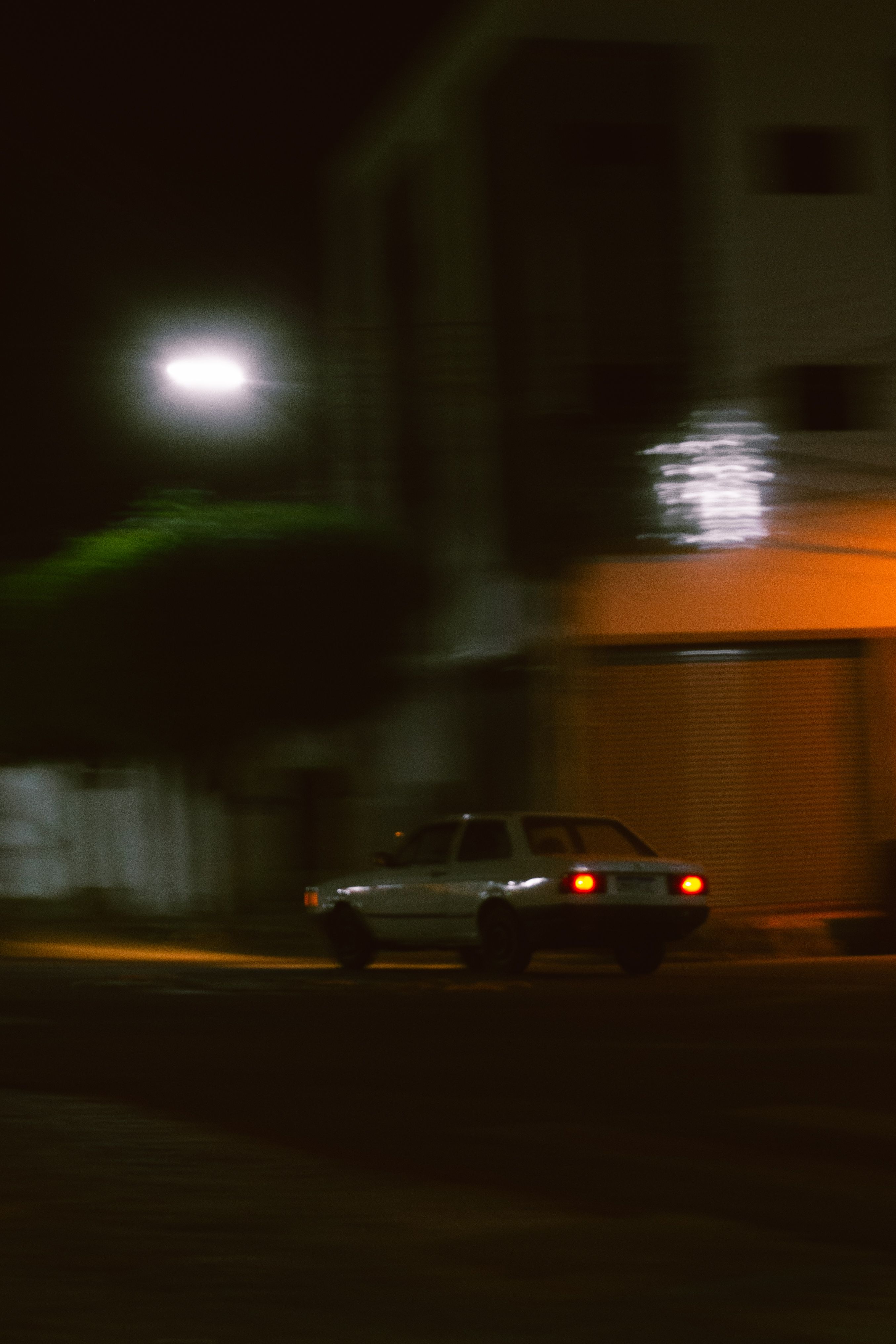 Vintage Car Driving at Night in Urban Setting · Free Stock Photo