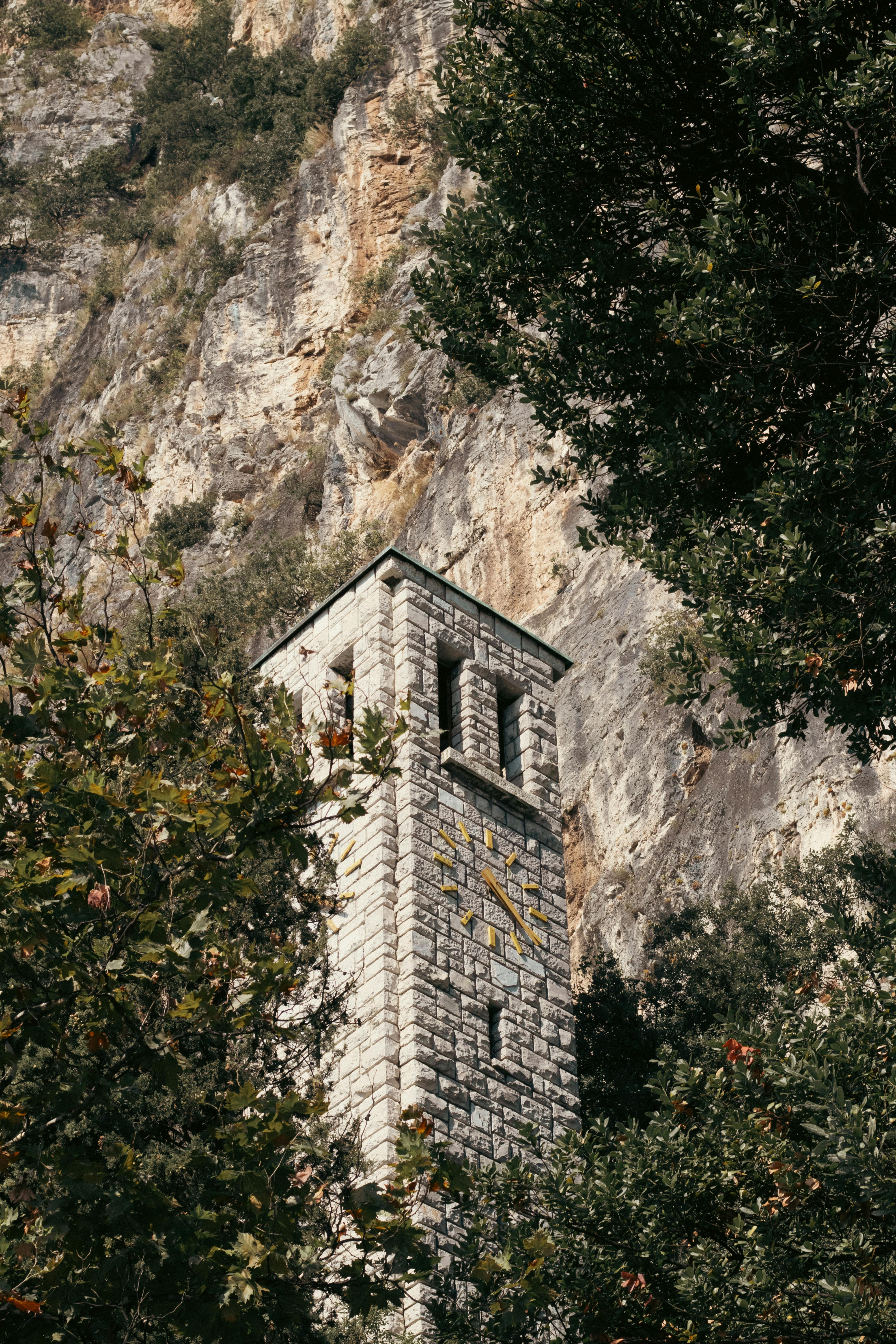 Ancient Stone Tower in Mountainous Forest · Free Stock Photo