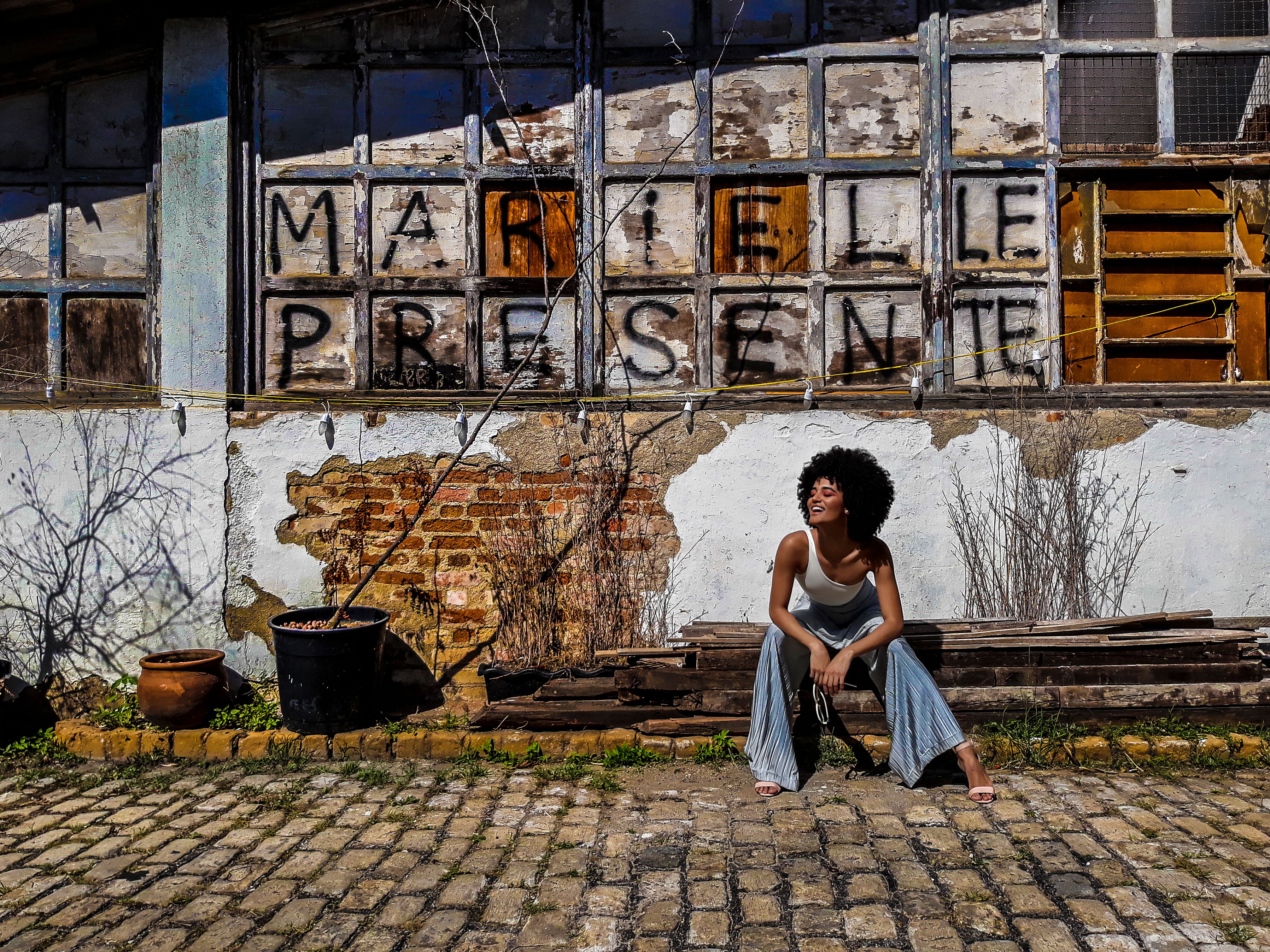 Woman Sitting Outside An Old Building · Free Stock Photo