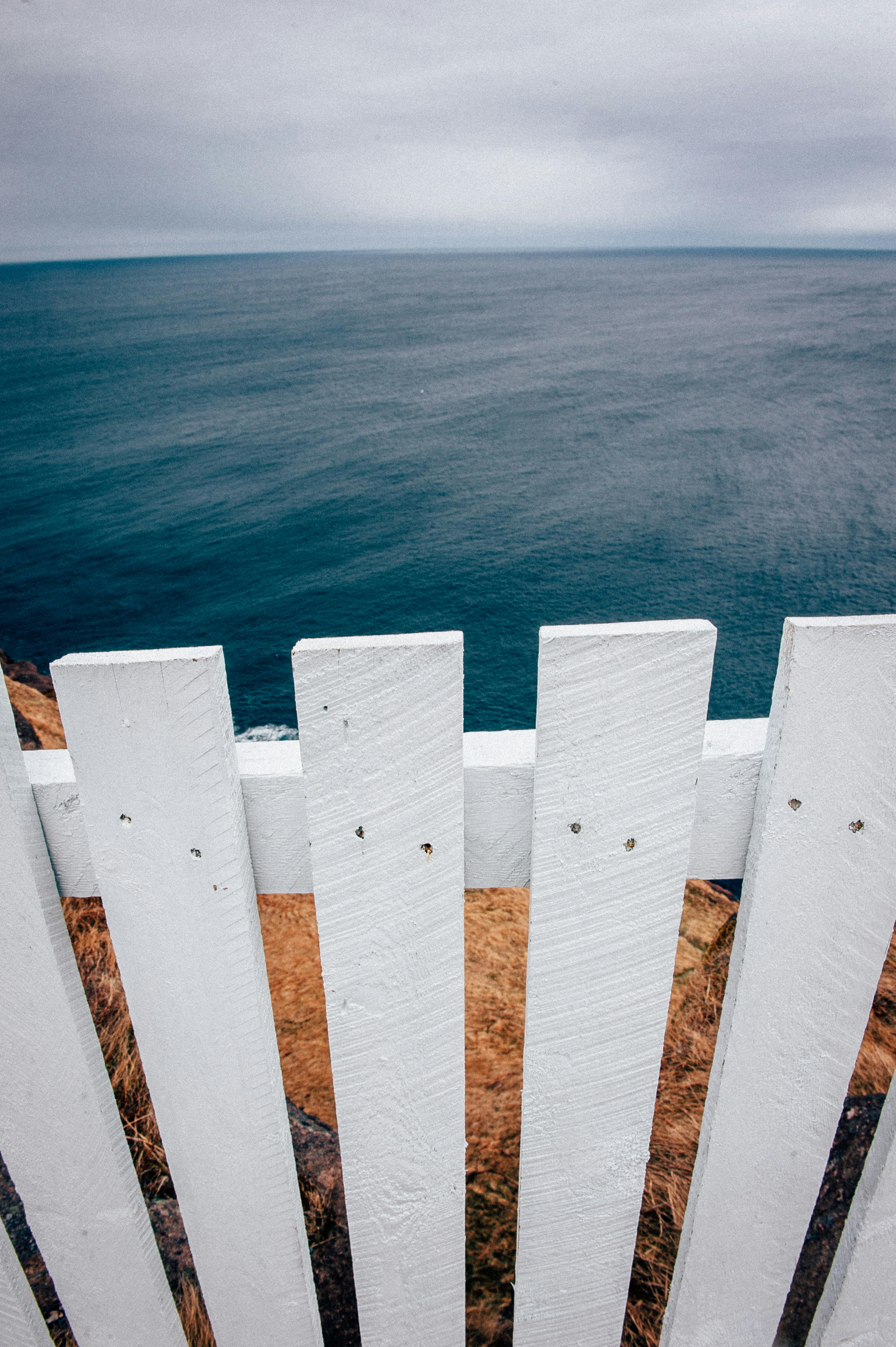 White Wooden Fence Beside Body of Water · Free Stock Photo