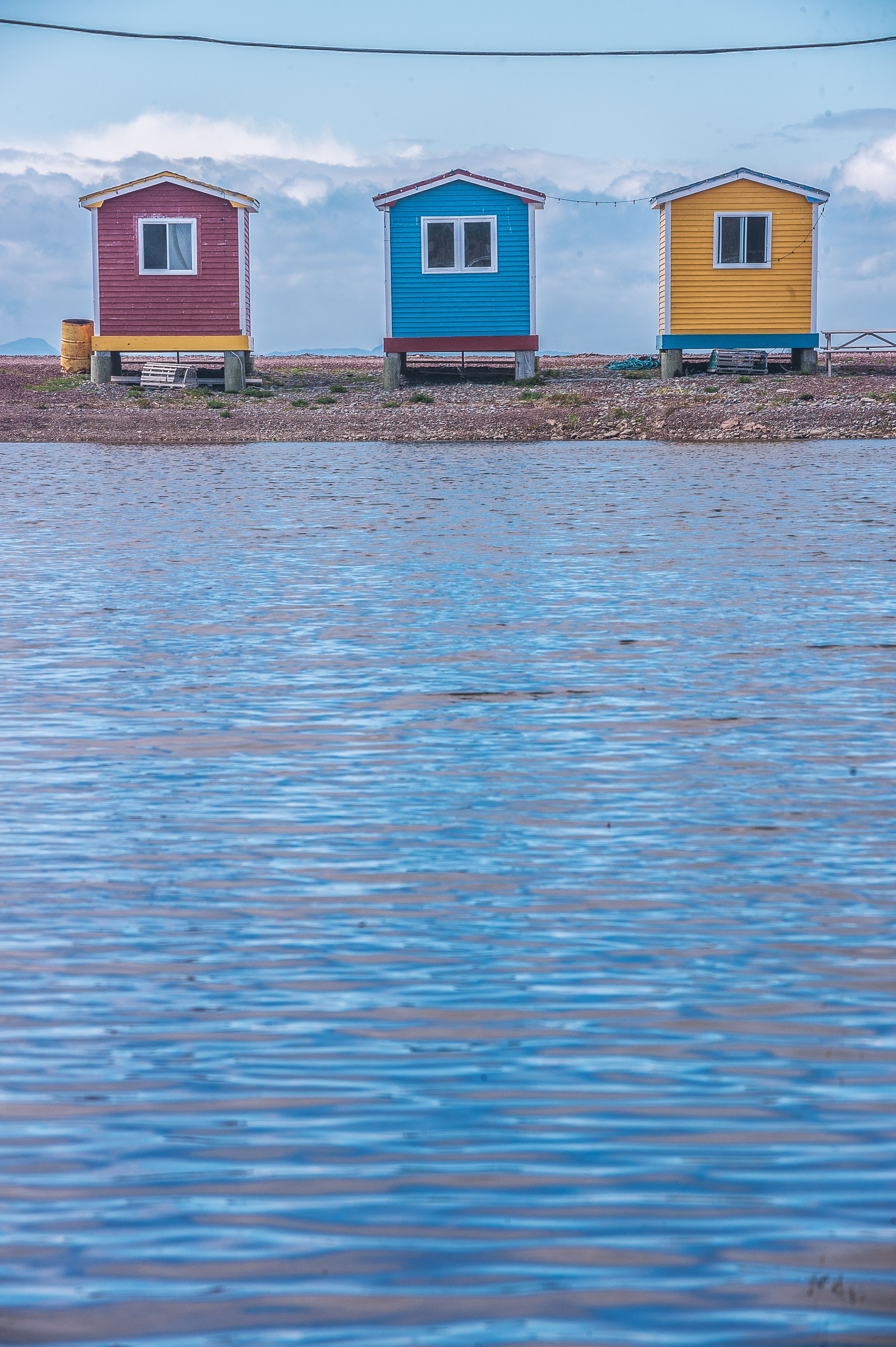 Three Assorted-color Wooden Mini Houses Facing Sea · Free Stock Photo