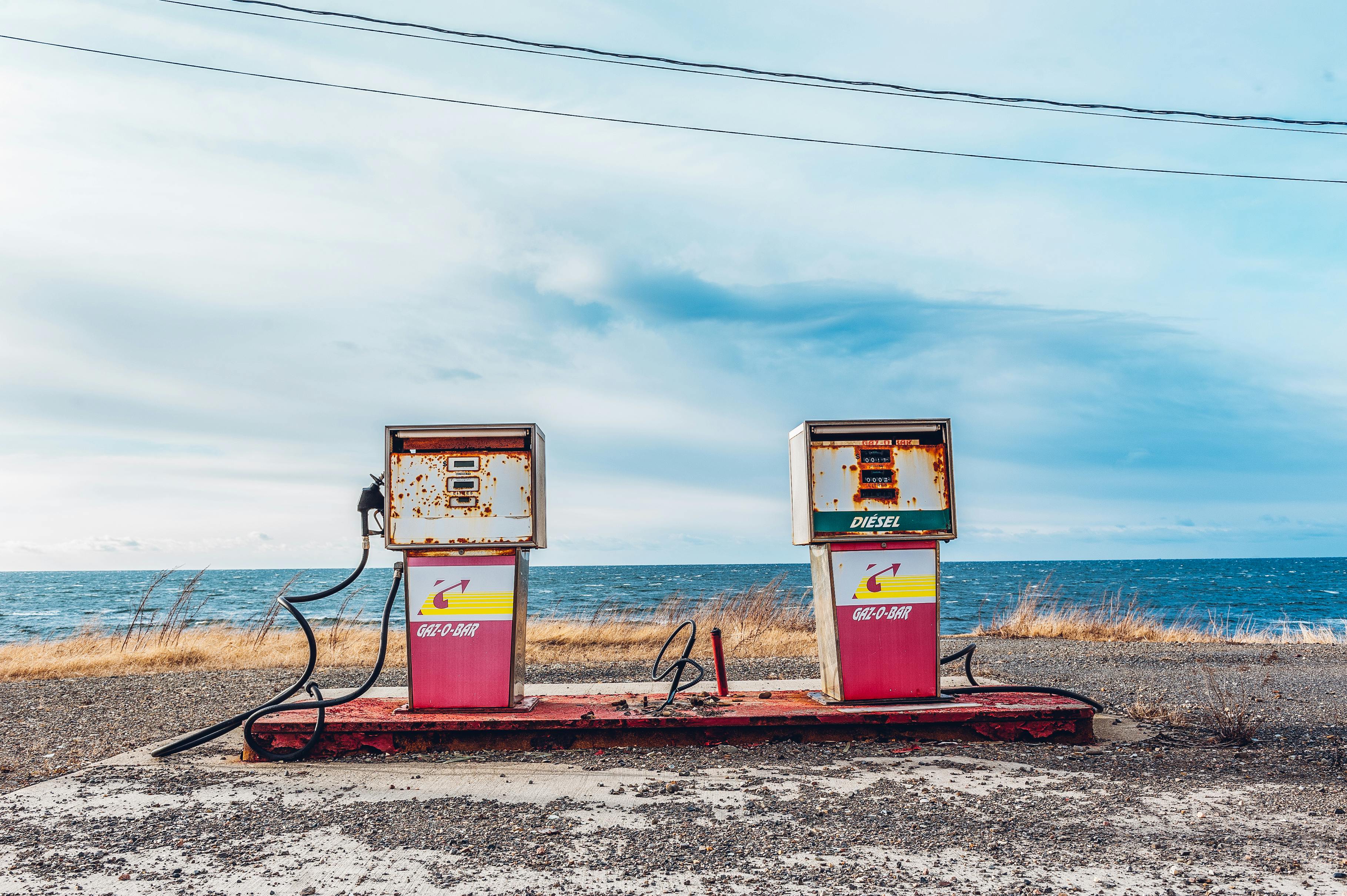 White and Pink Gasoline Station Near Ocean · Free Stock Photo