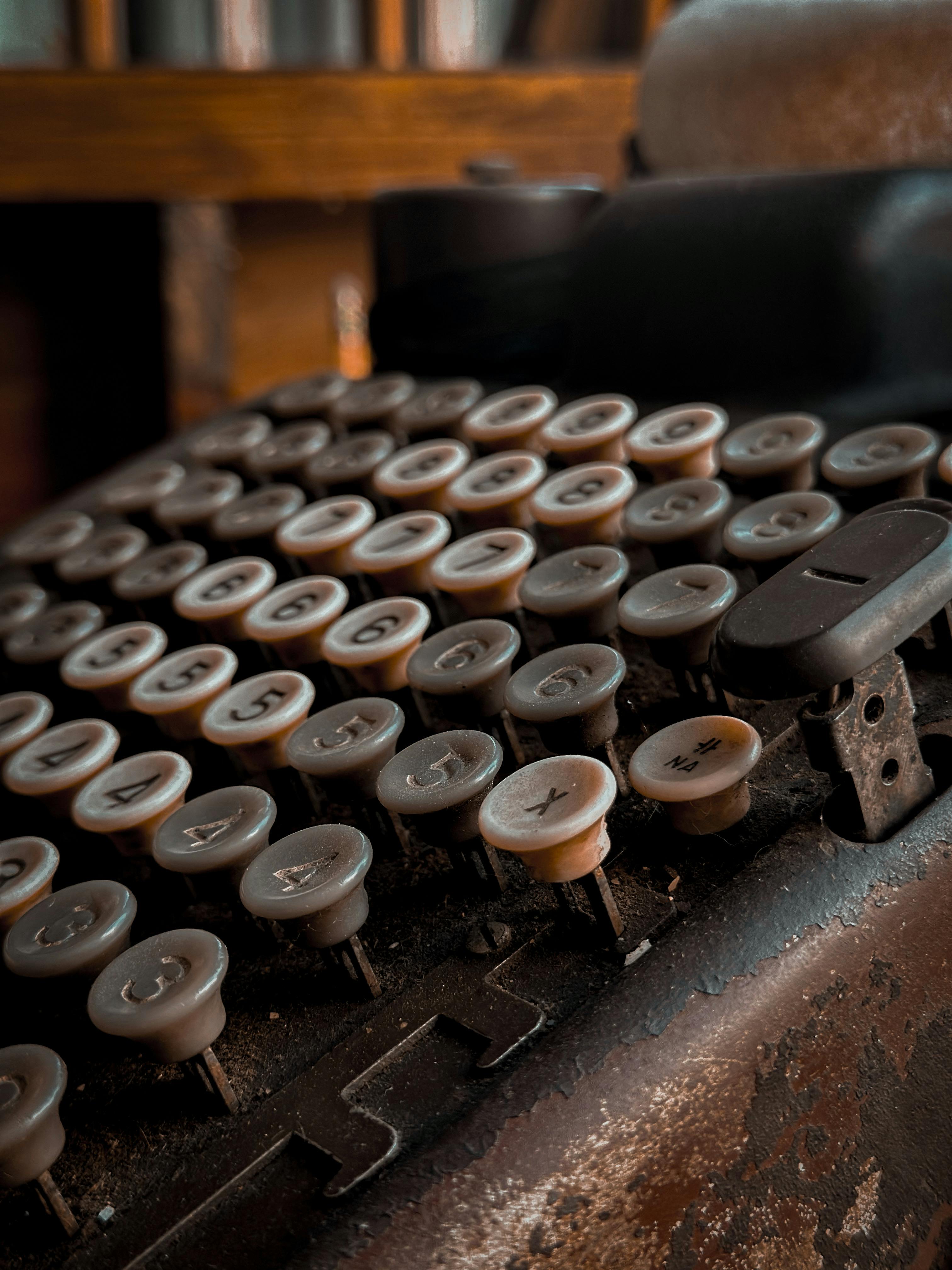 Vintage Typewriter Keys Close-up in Warm Light · Free Stock Photo