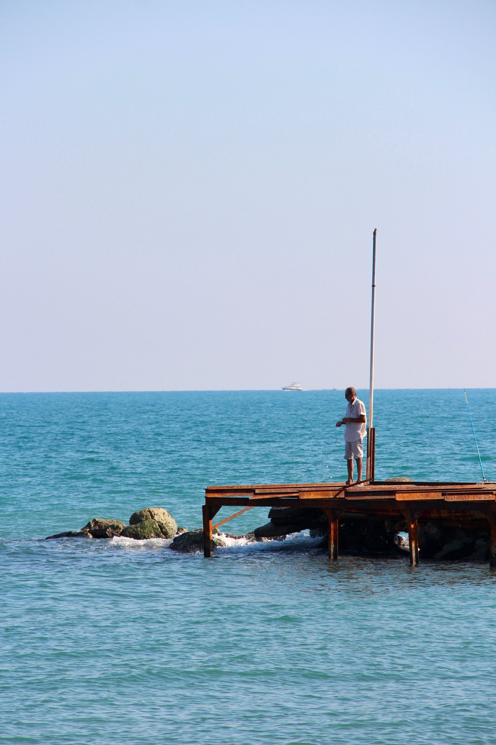 Man Fishing on a Pier in Mersin, Türkiye · Free Stock Photo