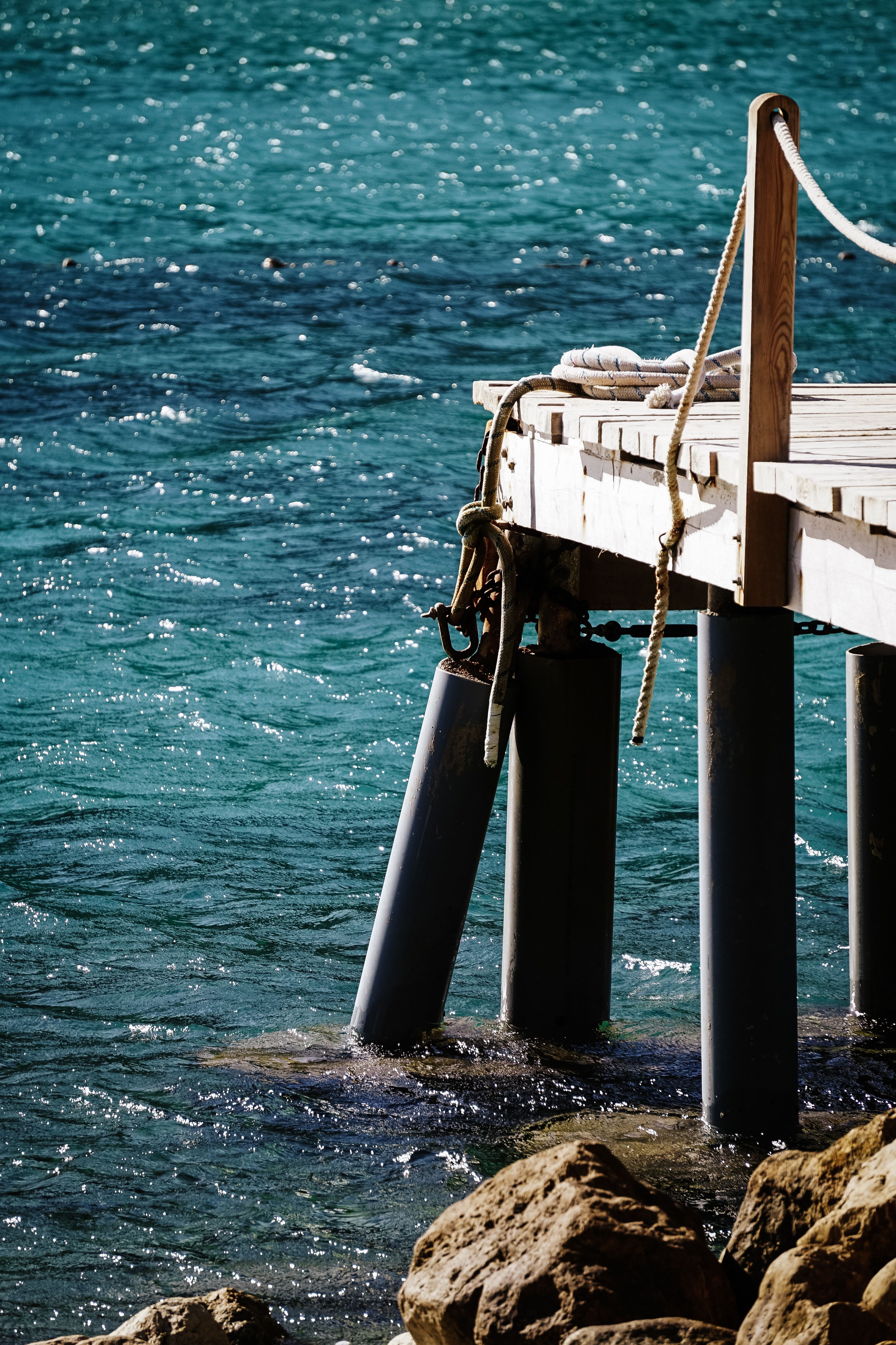 Sunny Pier Overlooking Clear Blue Ocean Waters · Free Stock Photo