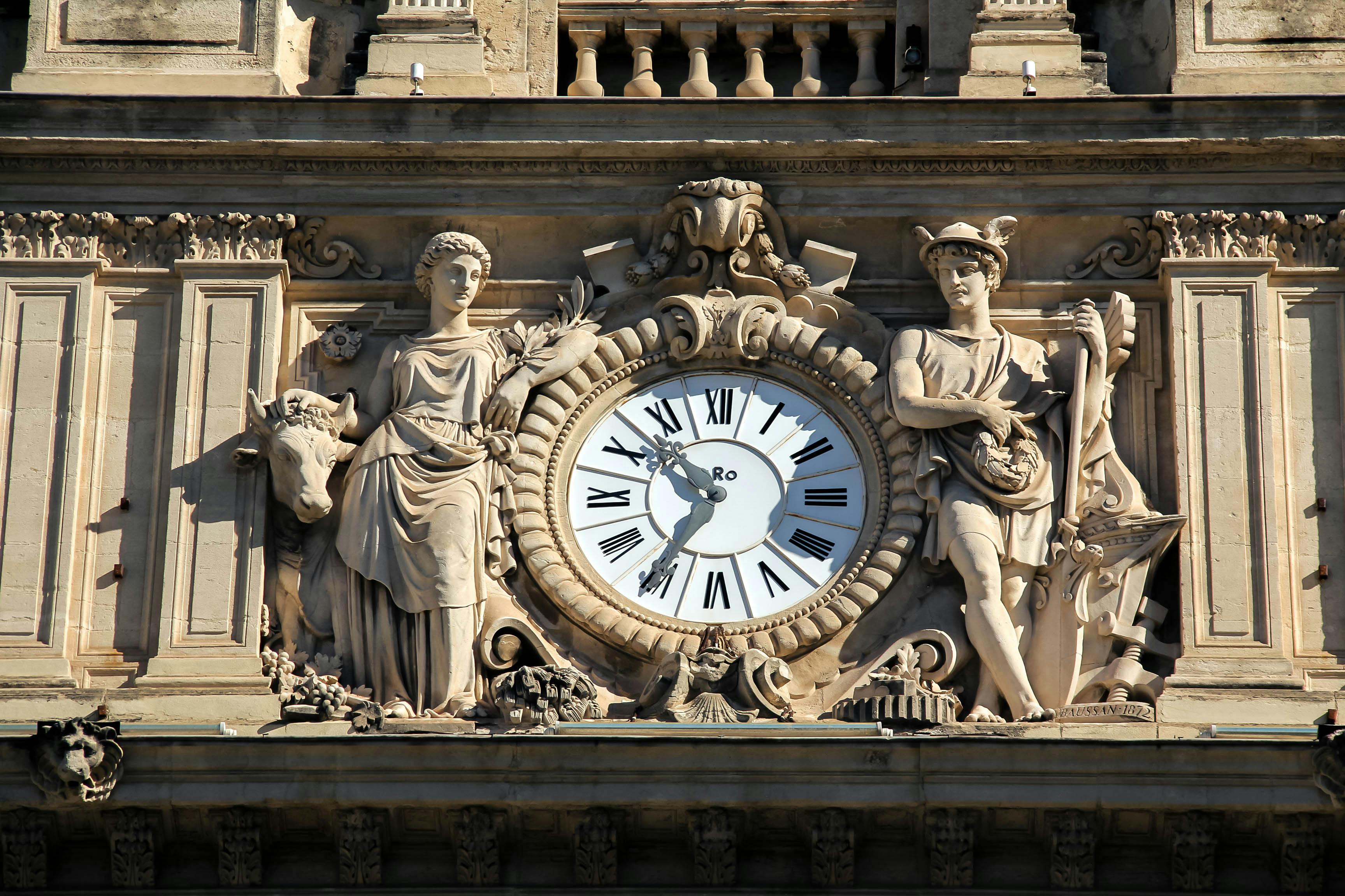 Ornate Clock with Classical Statues on Building · Free Stock Photo