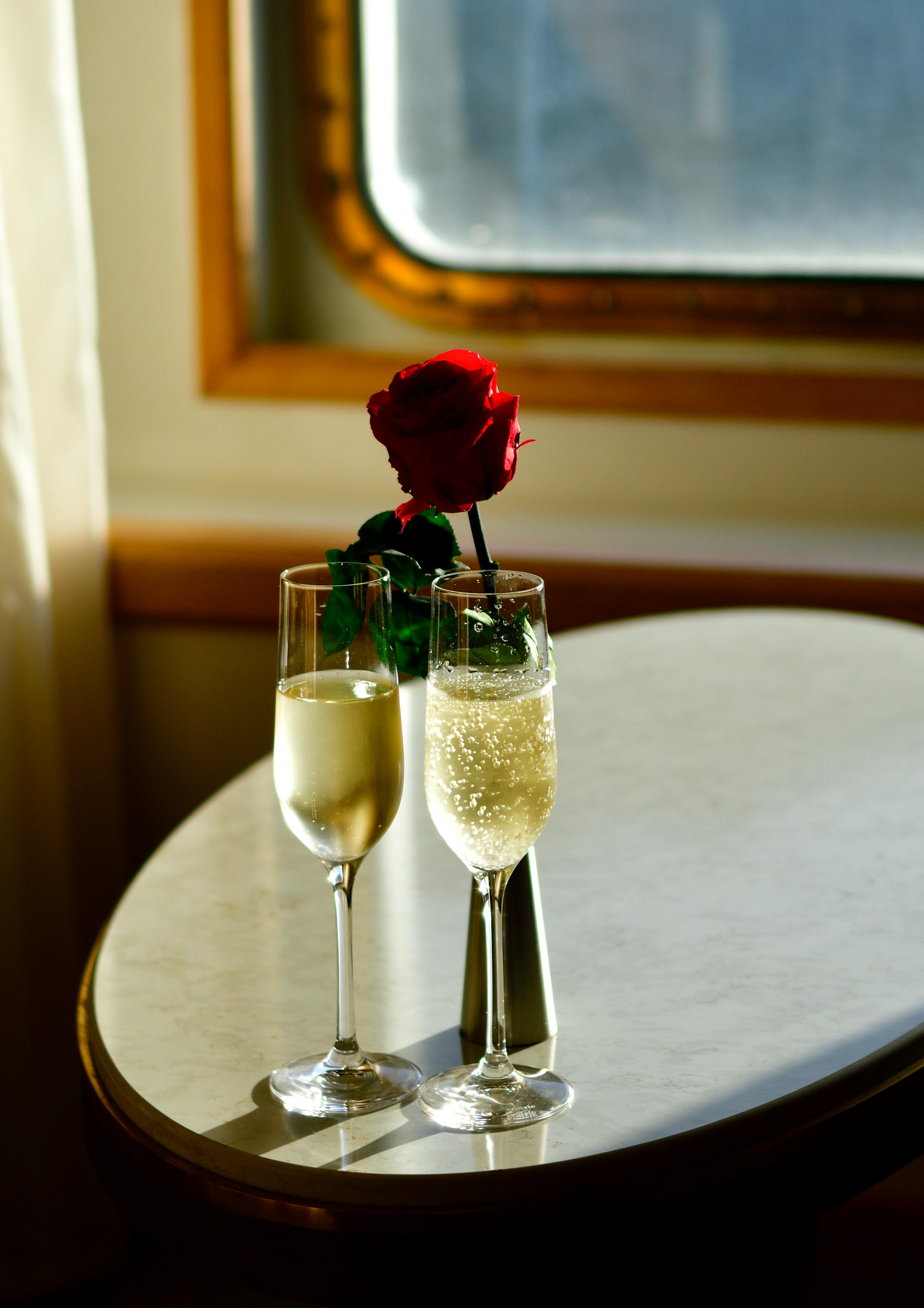 Romantic Champagne Setting by a Cruise Window · Free Stock Photo