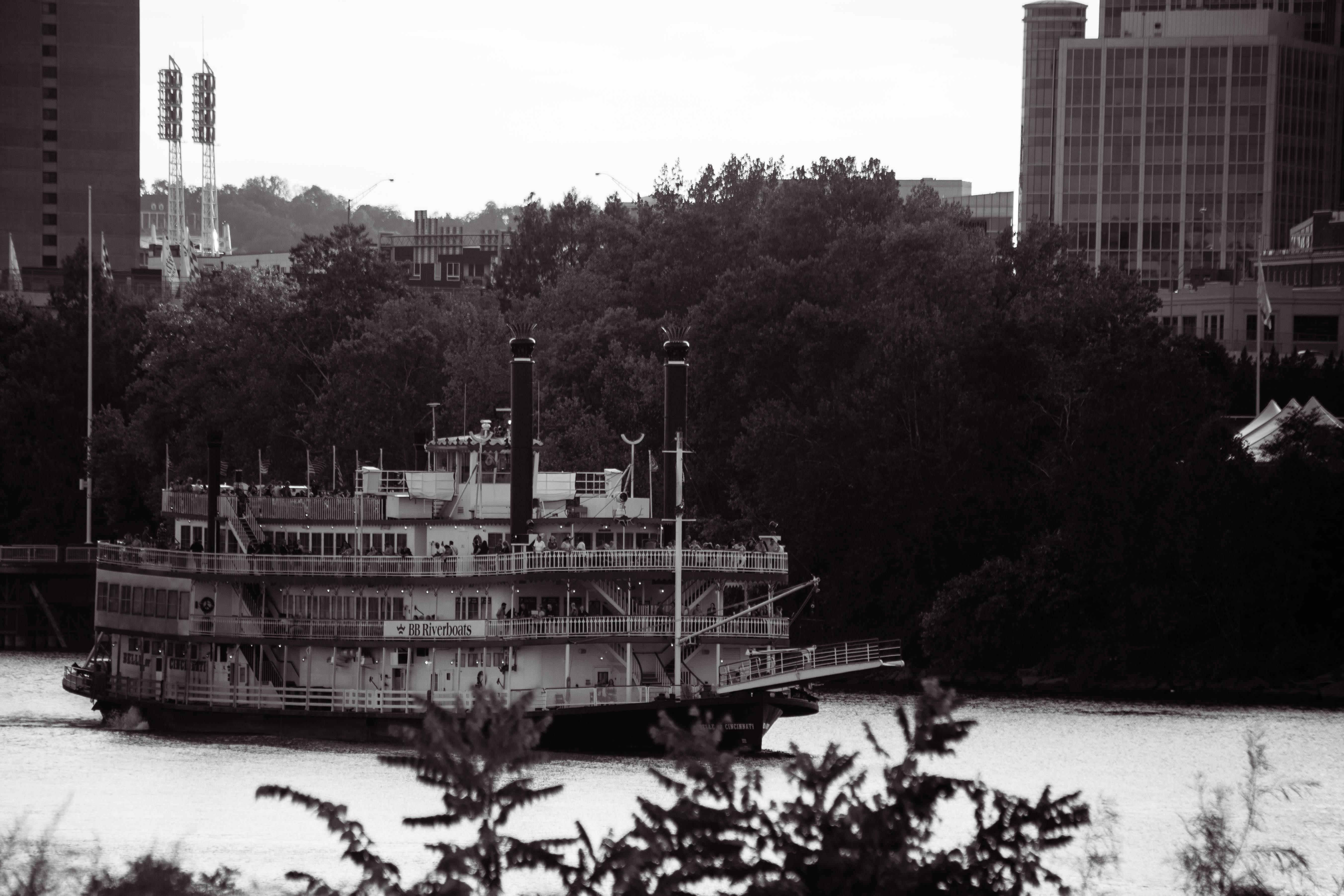 Historic Riverboat Cruising Past Cityscape · Free Stock Photo