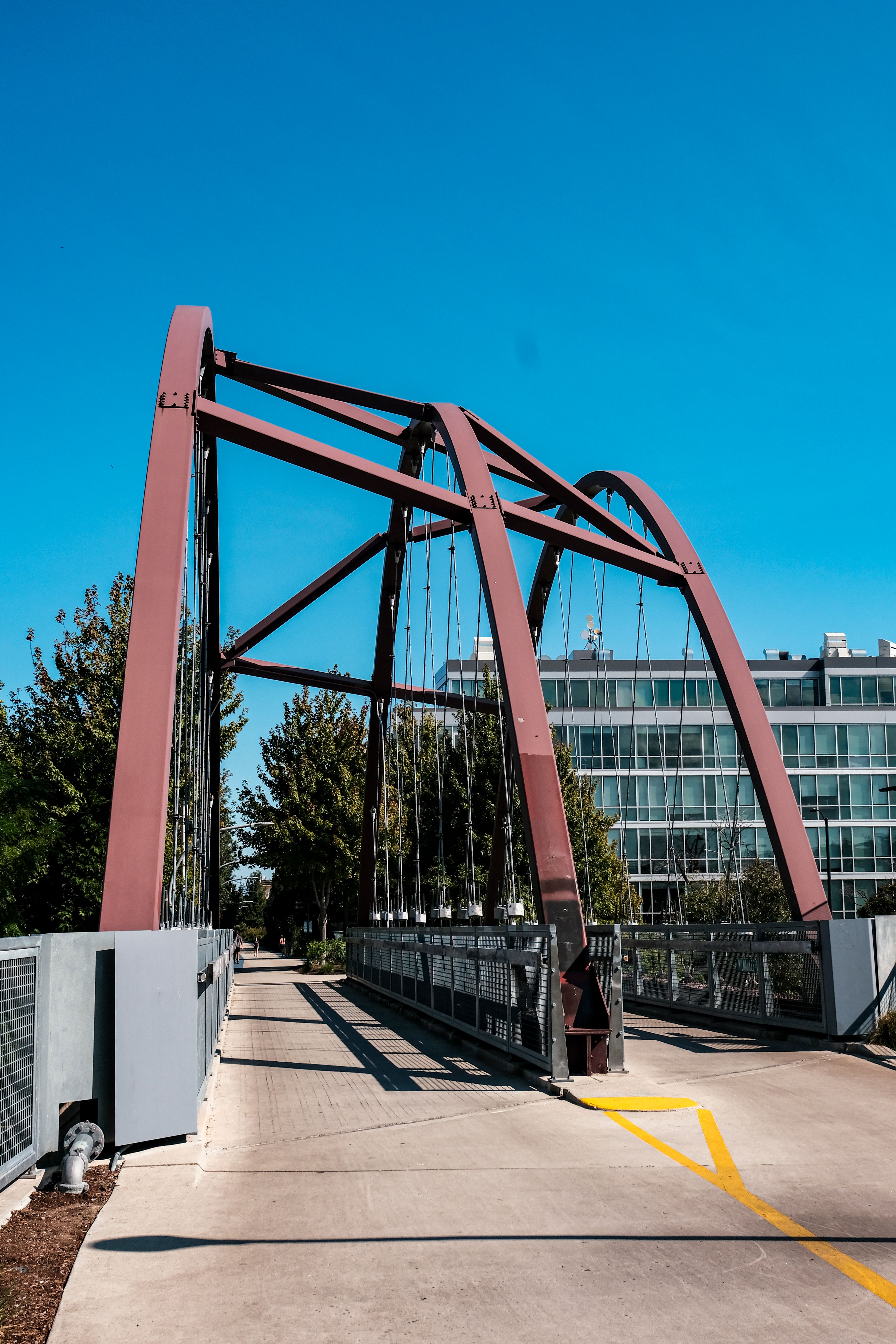 Modern Pedestrian Bridge in Urban Park Setting · Free Stock Photo