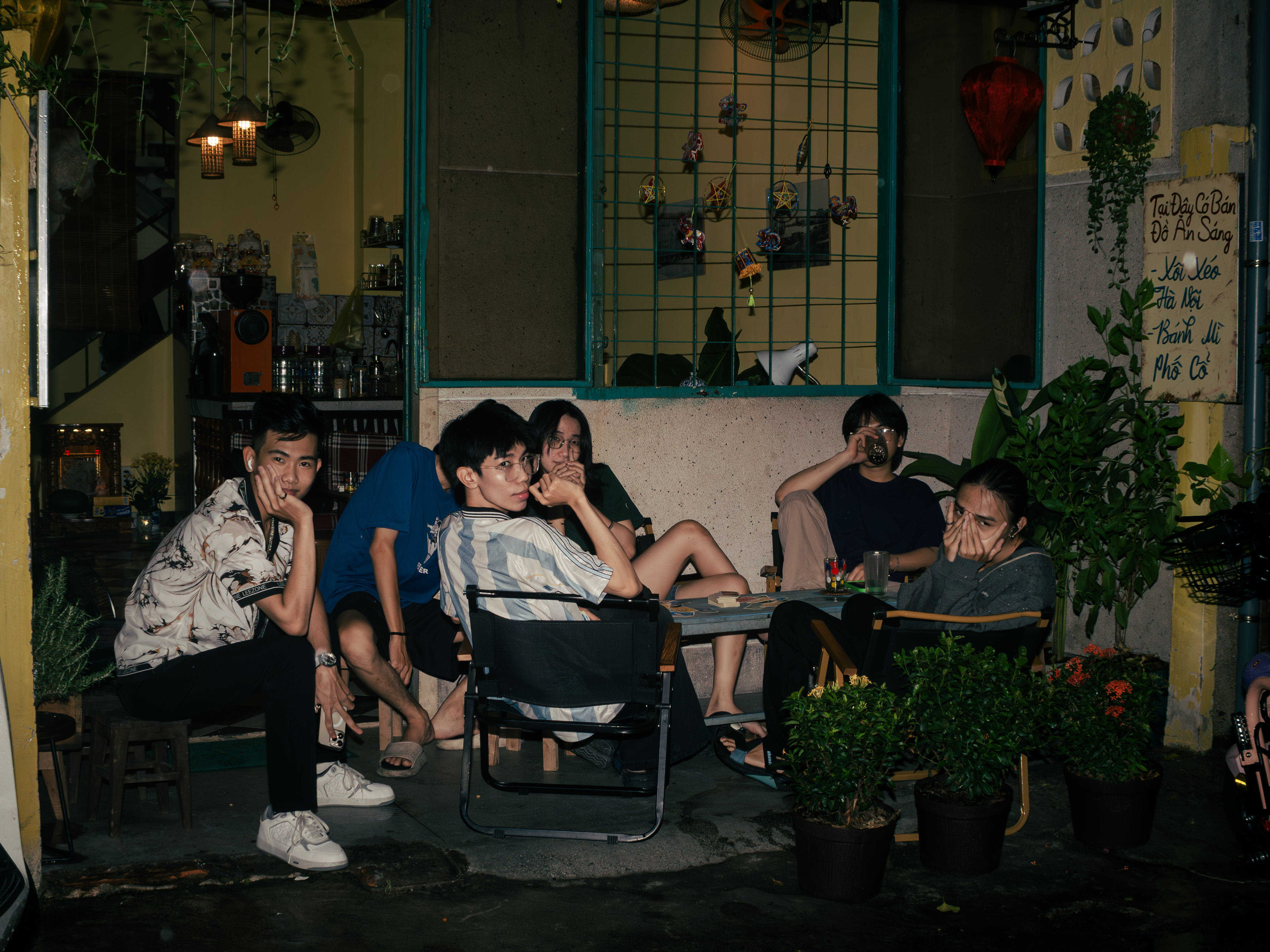 Friends Relaxing at an Outdoor Cafe at Night · Free Stock Photo