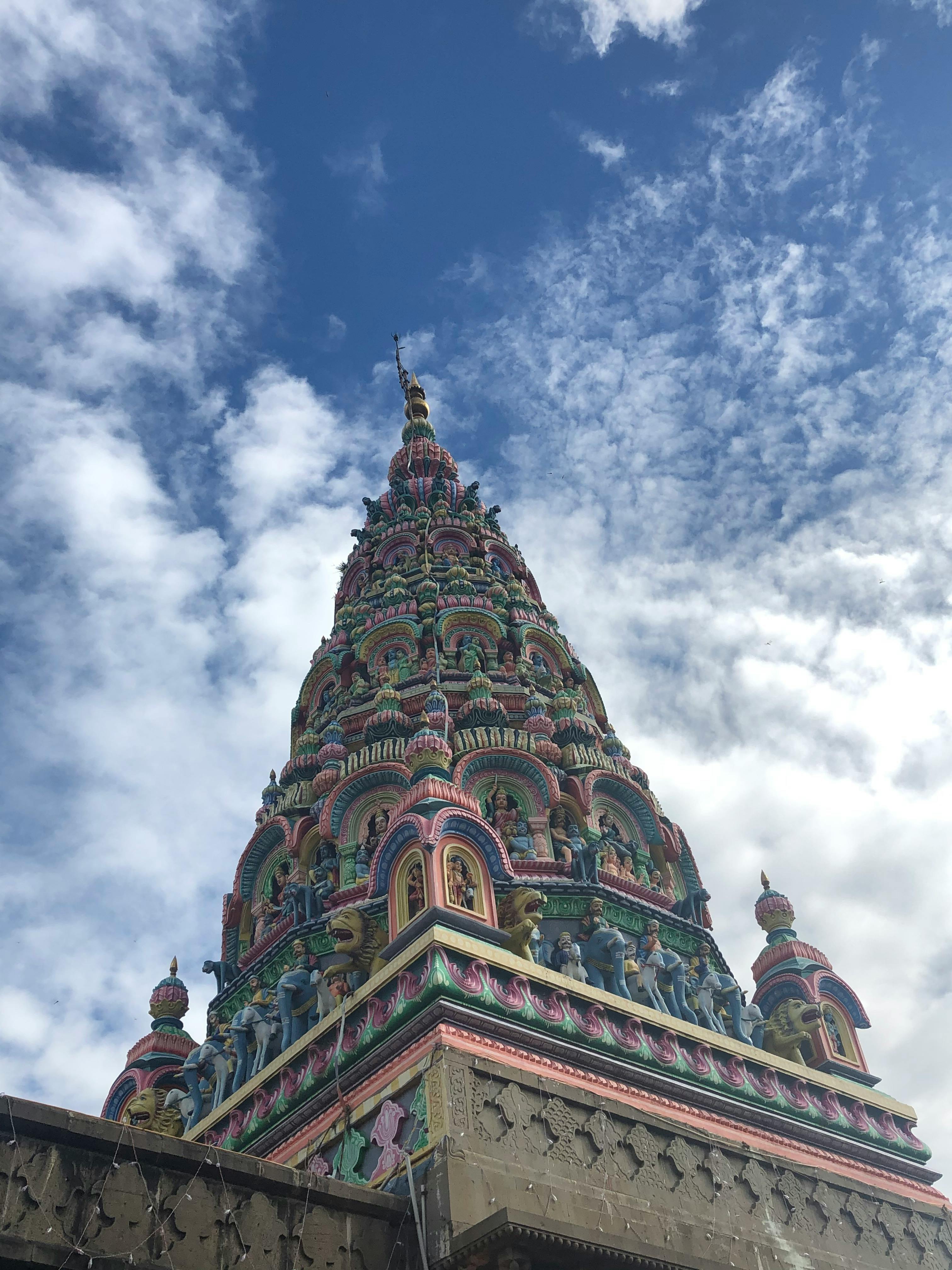 Colorful Hindu Temple Tower Against Blue Sky · Free Stock Photo