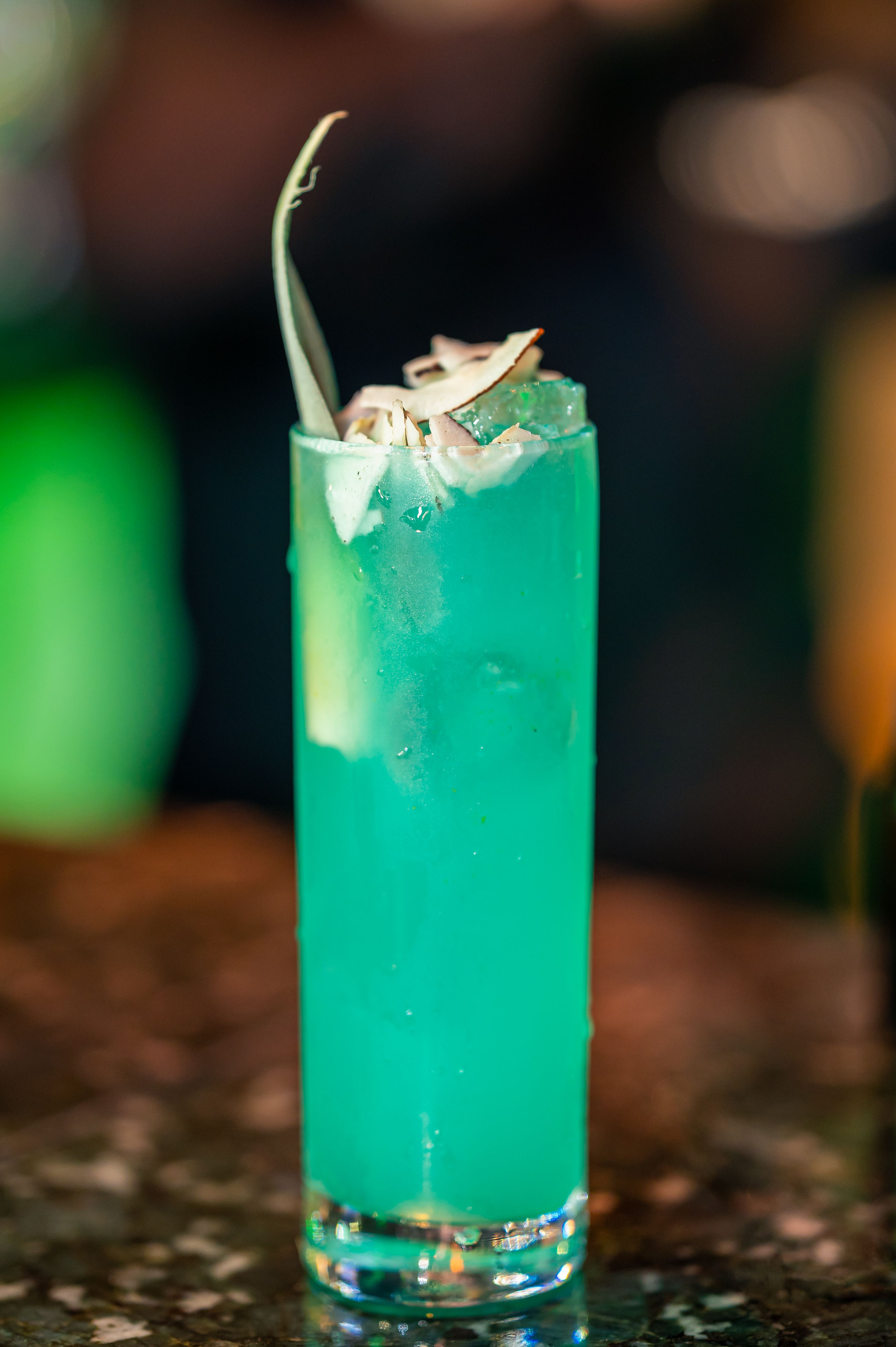 Vibrant Blue Cocktail on Rustic Bar Counter · Free Stock Photo