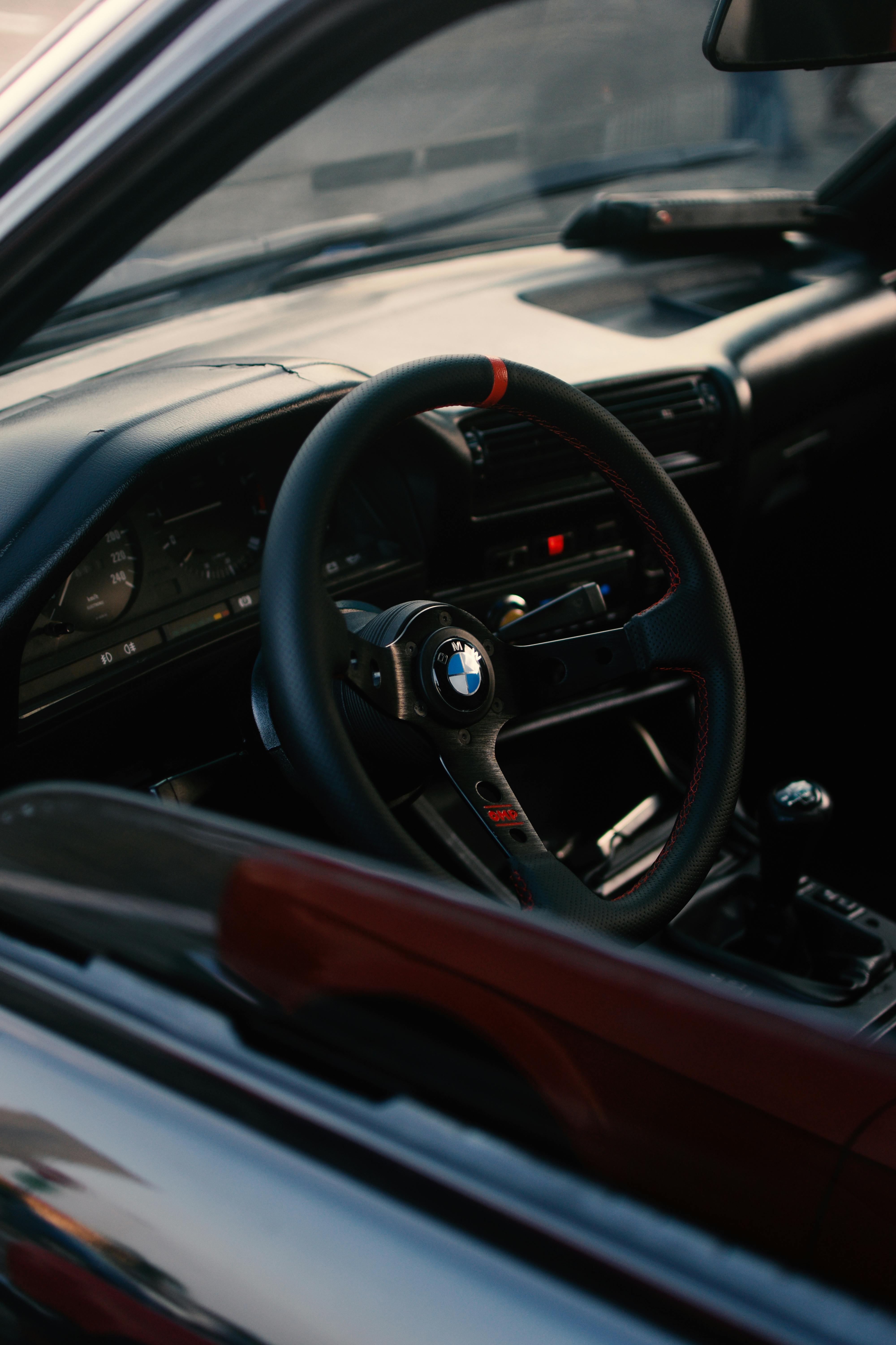 Person Holding Bmw Steering Wheel · Free Stock Photo
