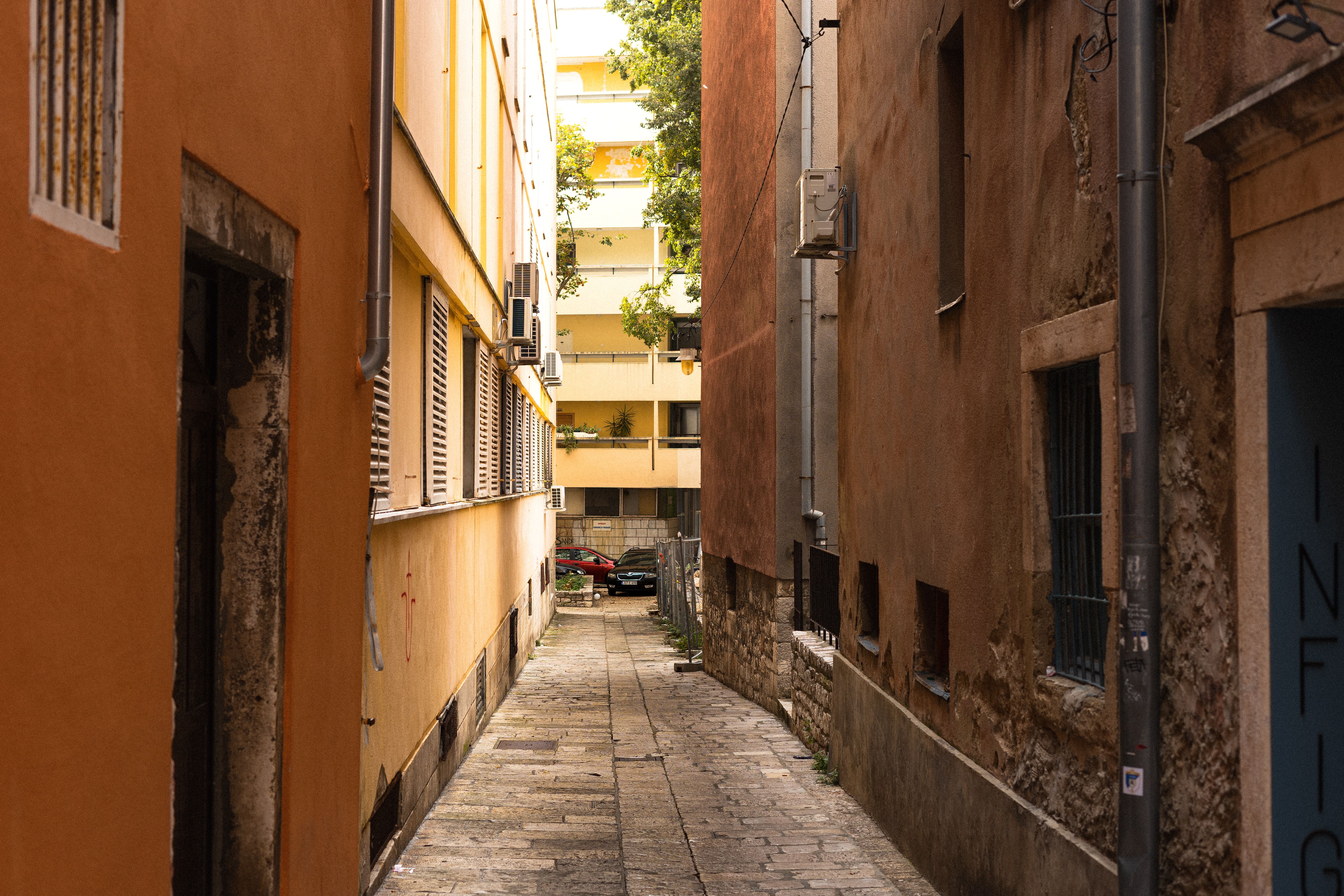 Charming Urban Alleyway with Rustic Walls · Free Stock Photo