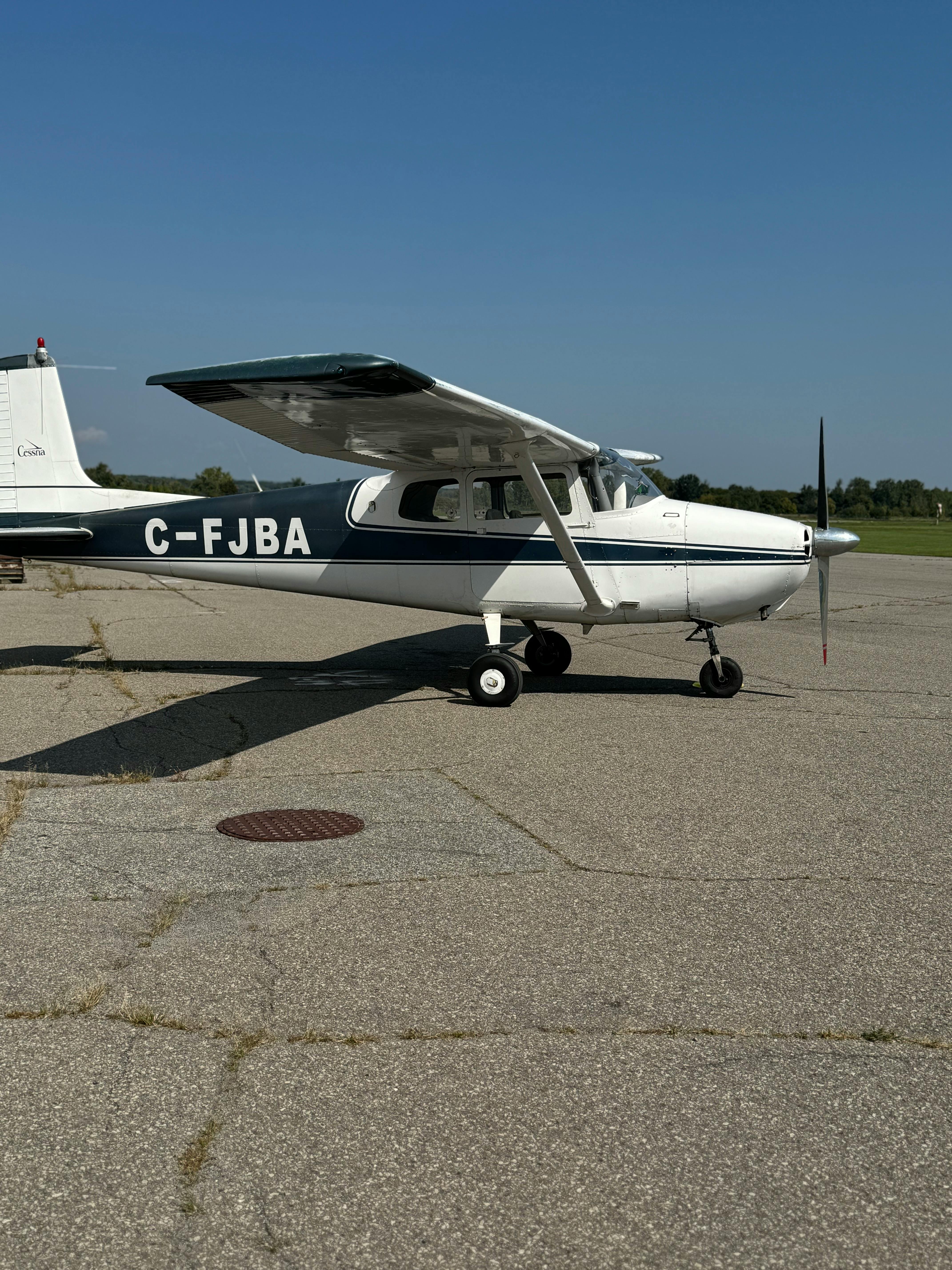 Small Aircraft on Runway Under Clear Blue Sky · Free Stock Photo