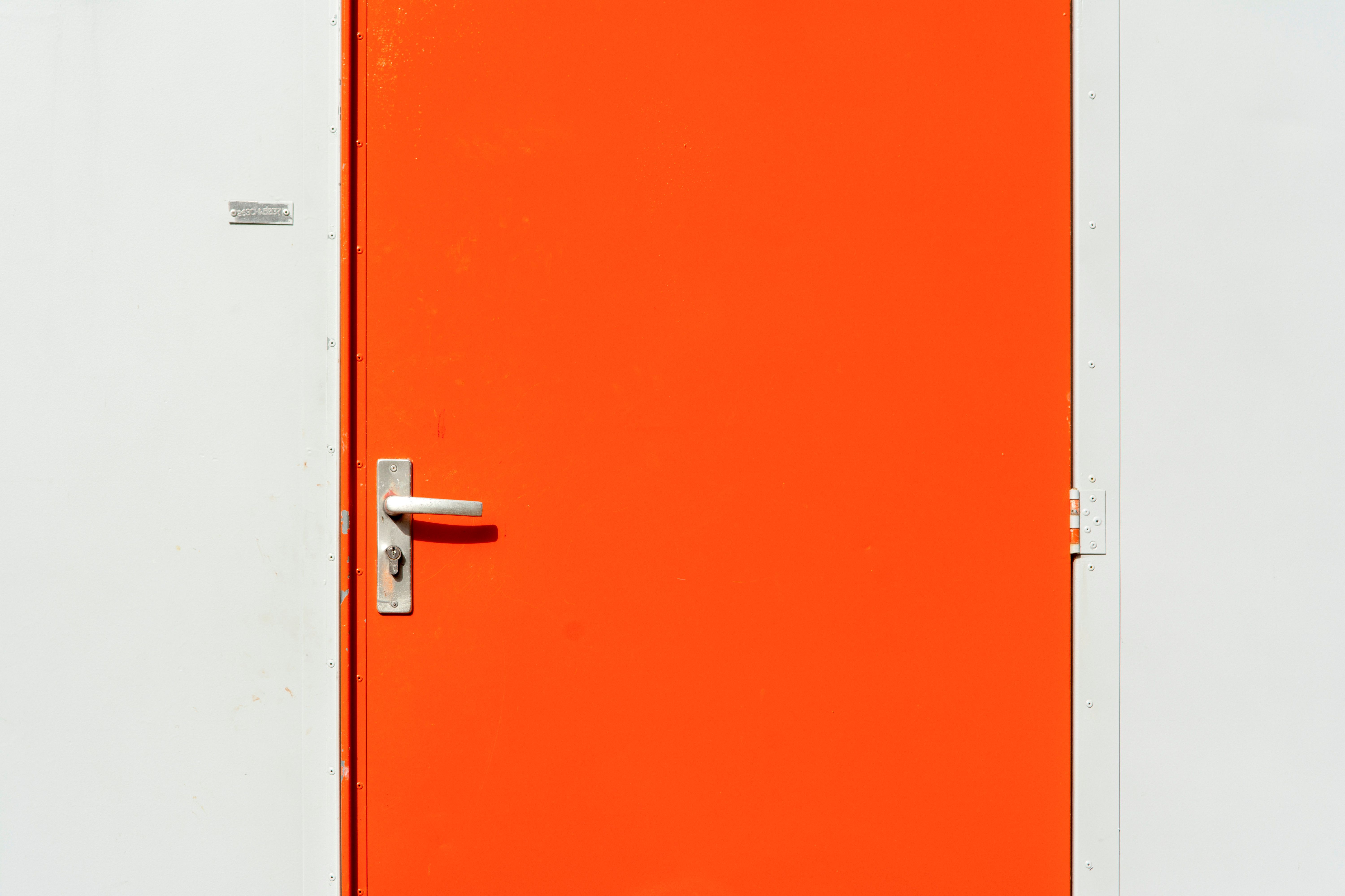 Vibrant Orange Door with Handle Bold Contrast · Free Stock Photo