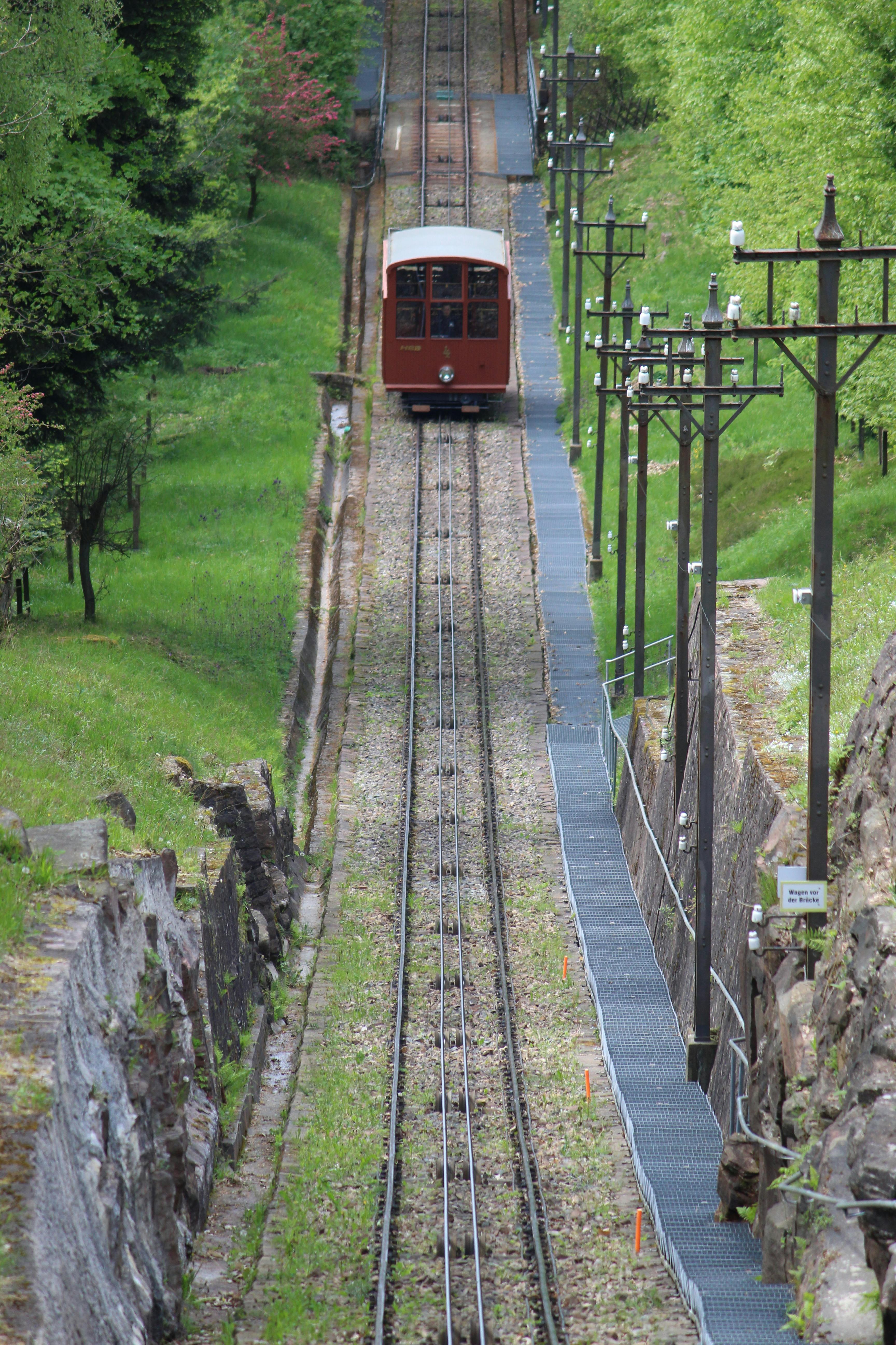 Red Funicular Train Ascending a Steep Hill · Free Stock Photo
