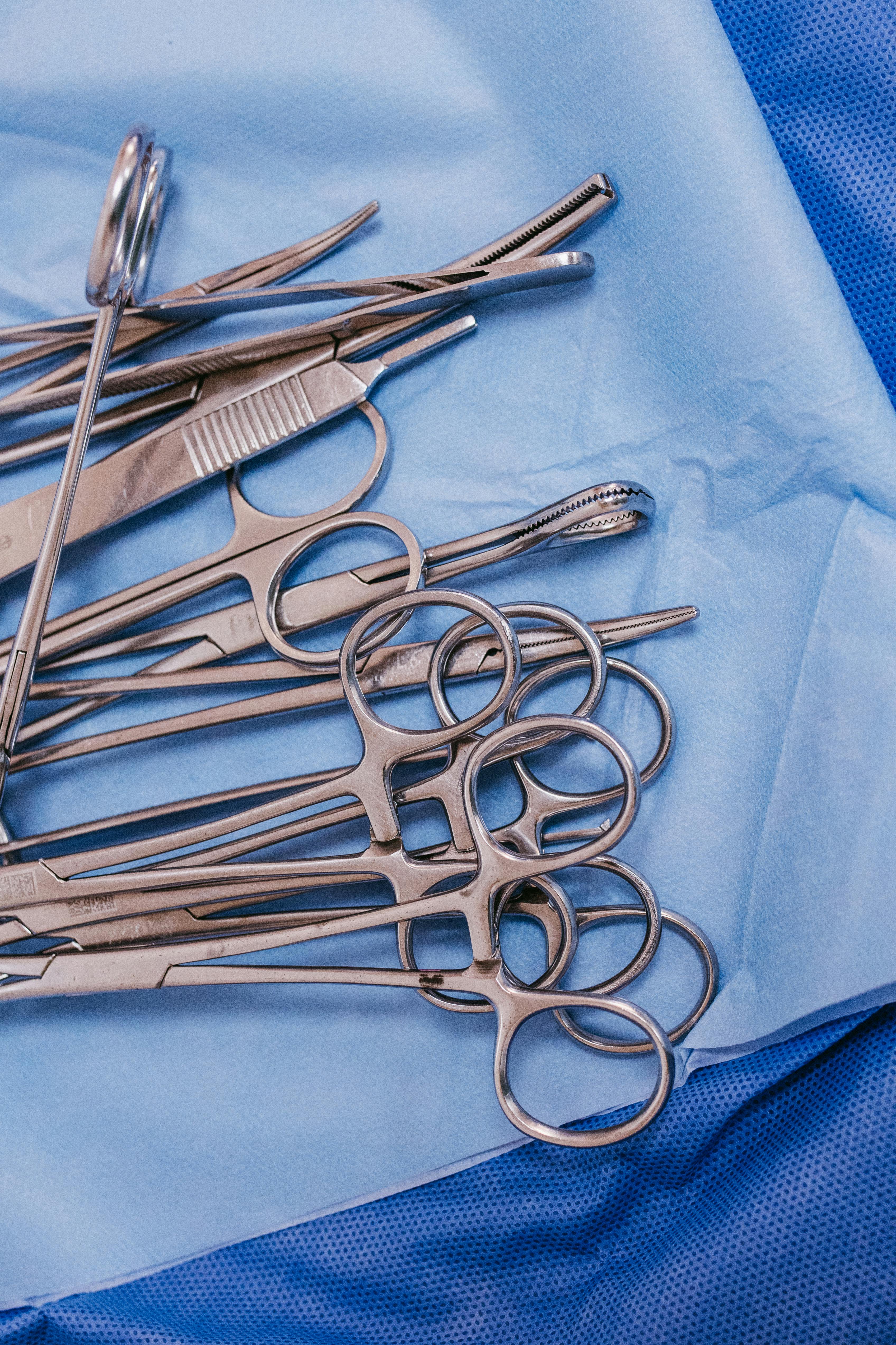 Sterile Surgical Instruments on Blue Drapes · Free Stock Photo