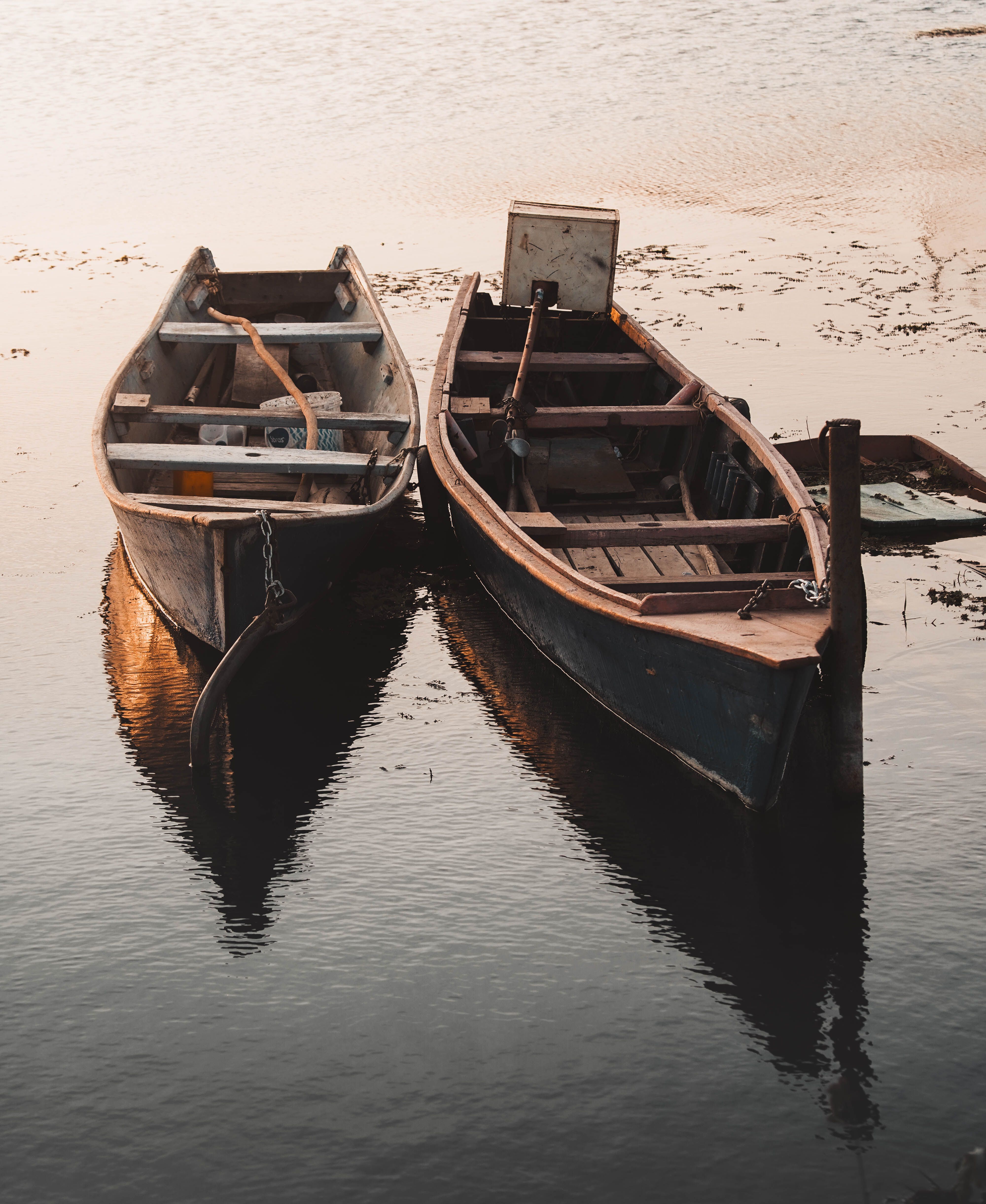 Serene Evening with Two Wooden Rowboats on Calm Water · Free Stock Photo