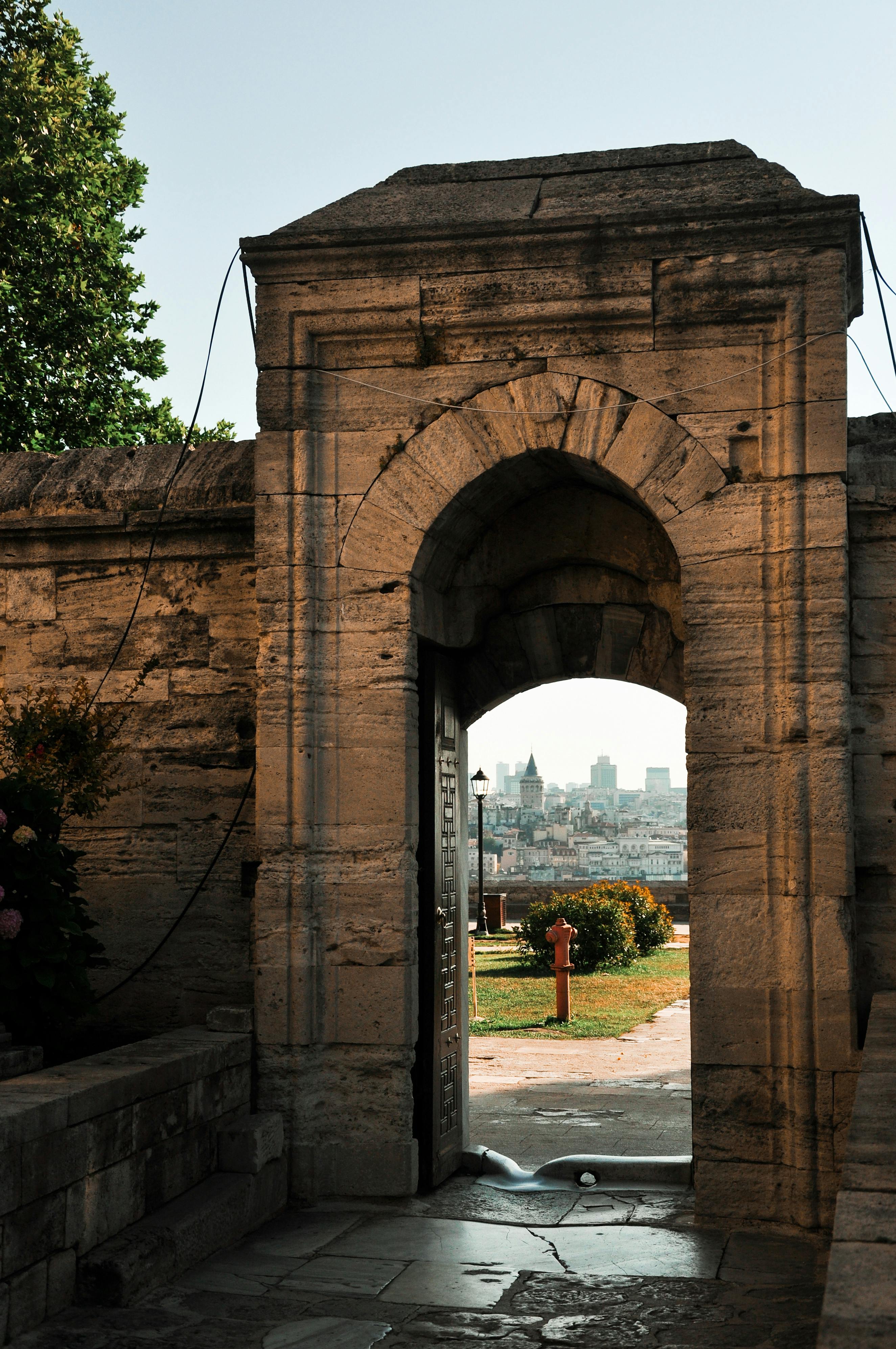 Historic Stone Archway with City View · Free Stock Photo